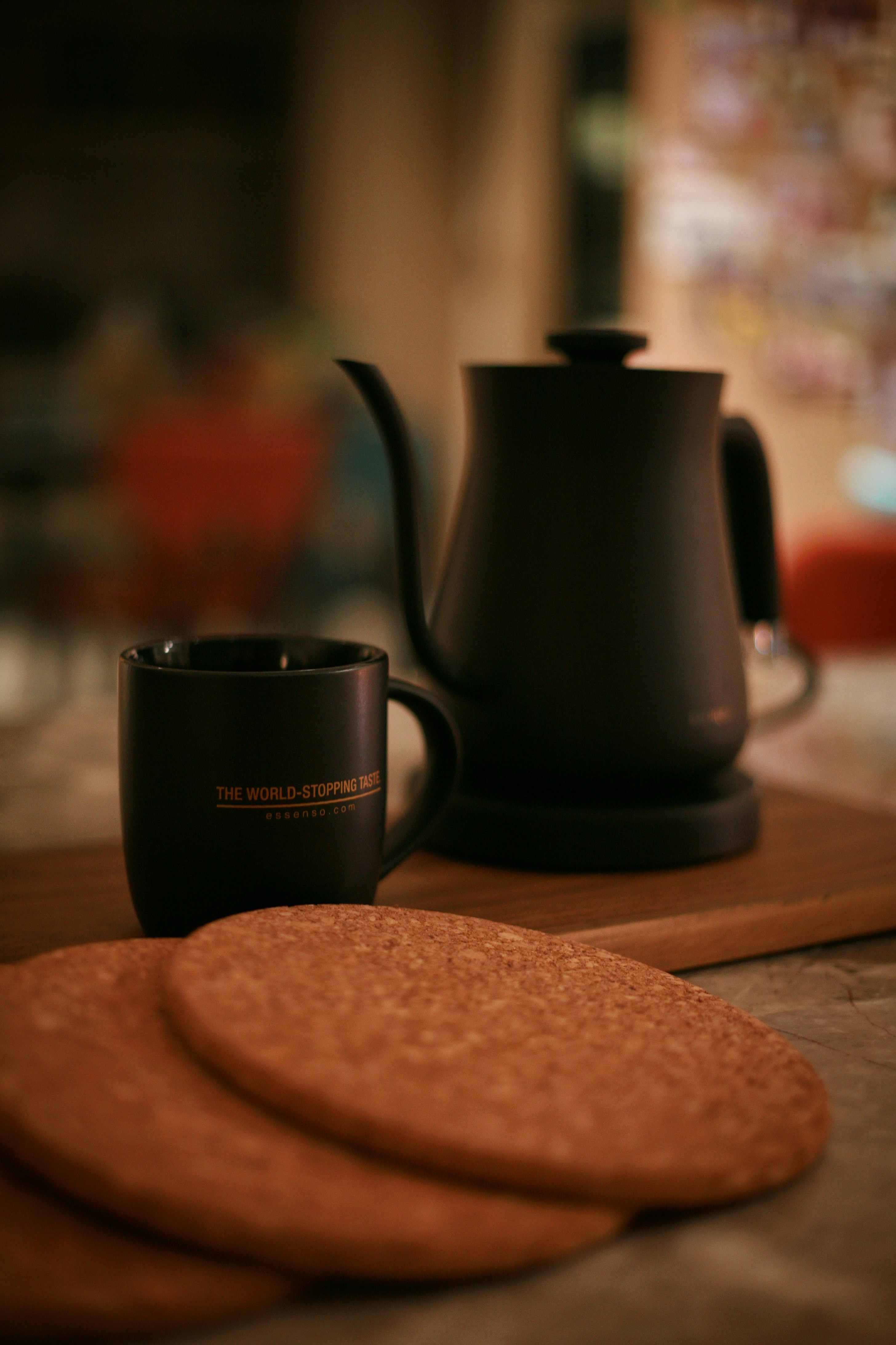 black ceramic teapot on brown wooden table