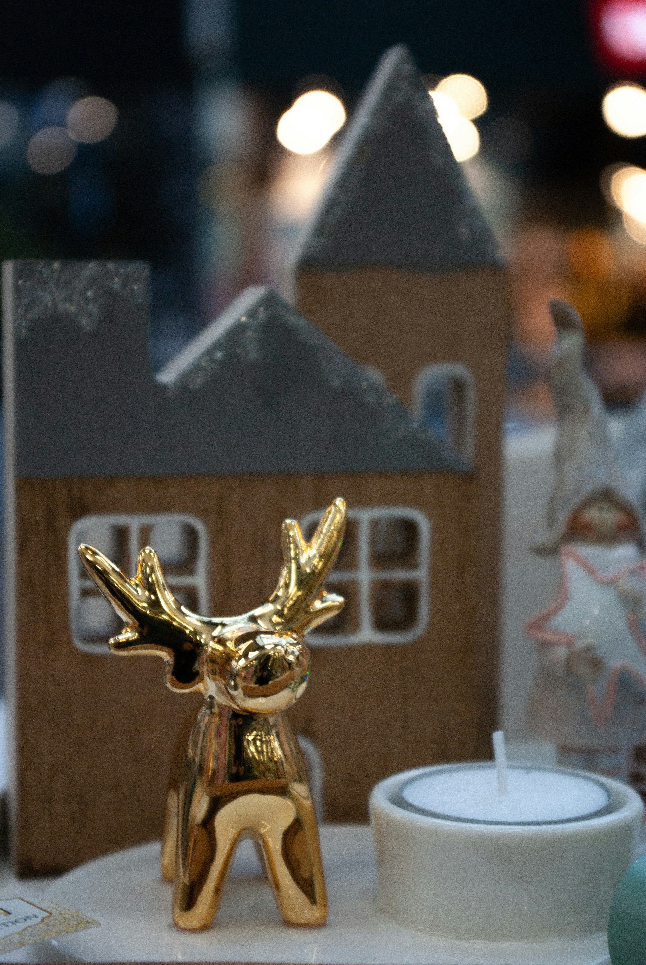 Golden Reindeer and Candle Scene in a Cozy Holiday Display