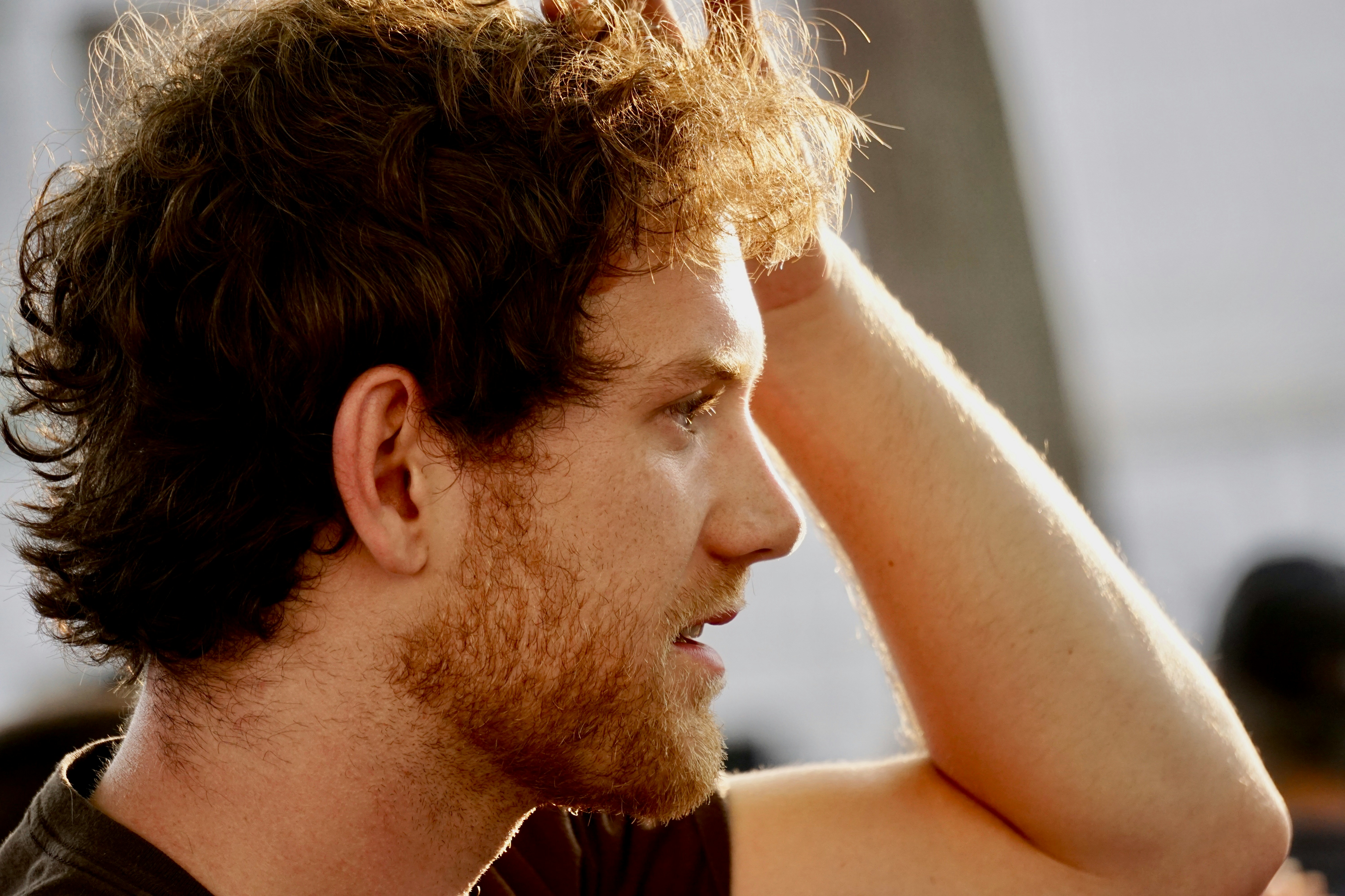 Contemplative Glance in Sunlit Moment
