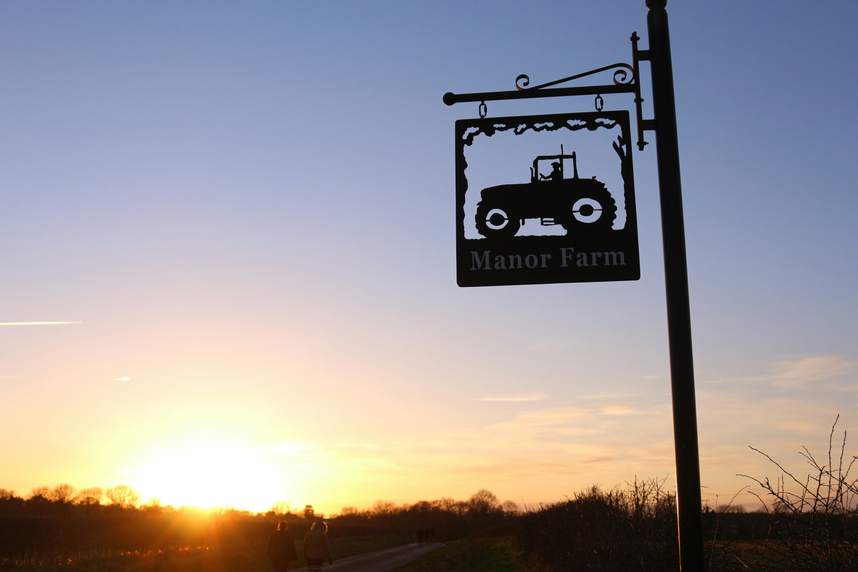 Sunset Silhouette: Rustic Tractor Sign