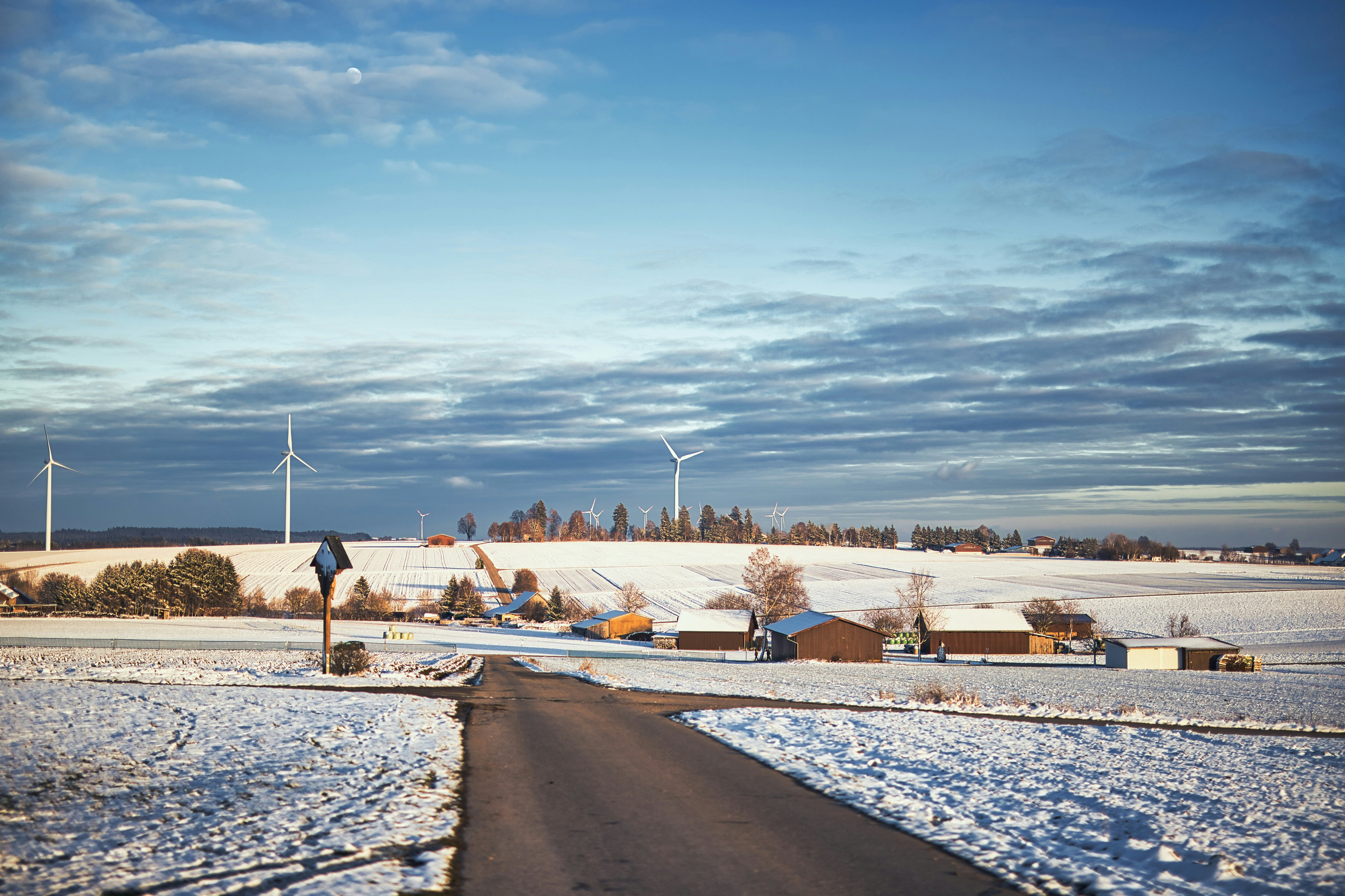 Snow-Covered Farmland with Wind Turbines Under a Wide Sky