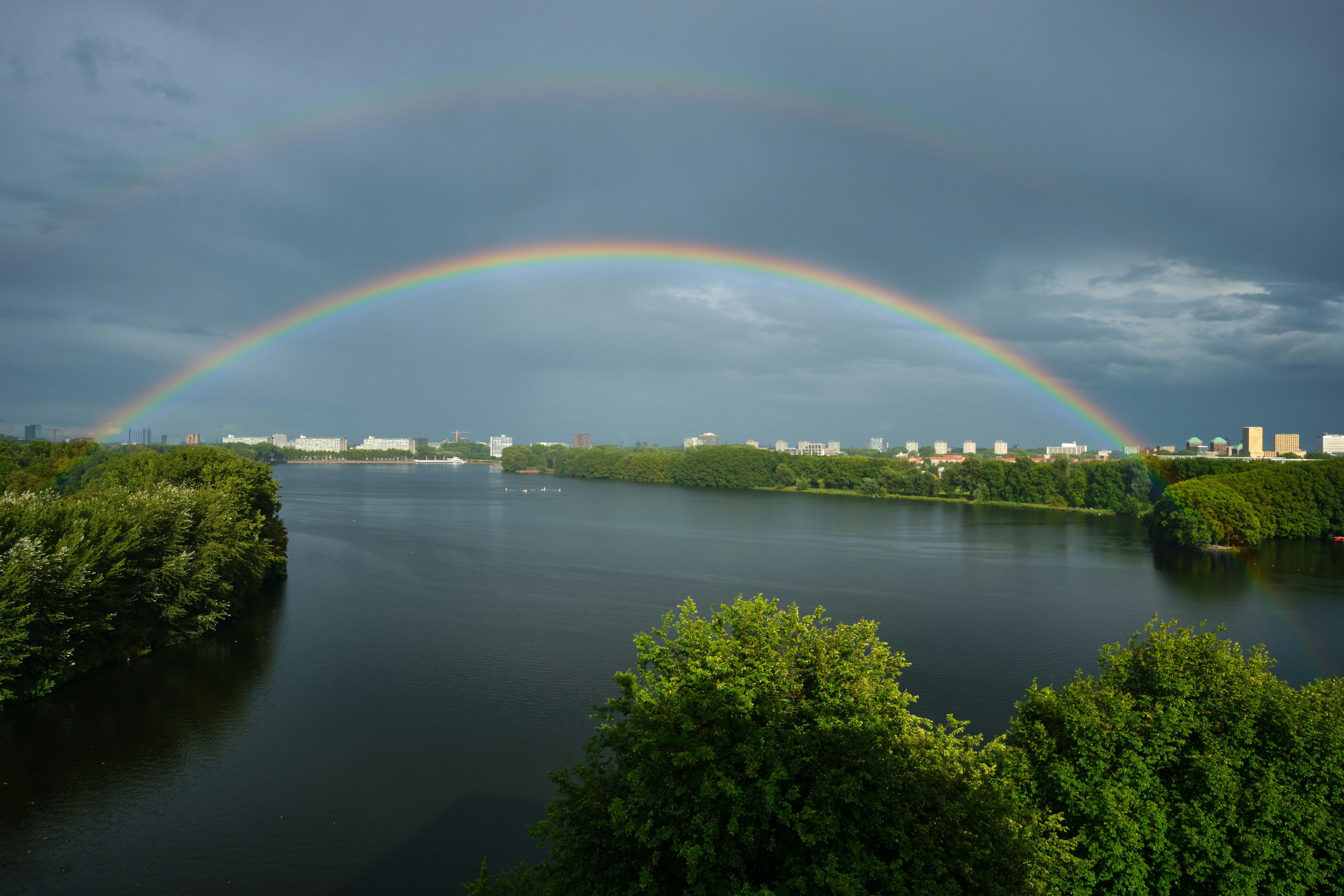 Rainbow over green trees and lake photo – Free Sloterplas Image on Unsplash