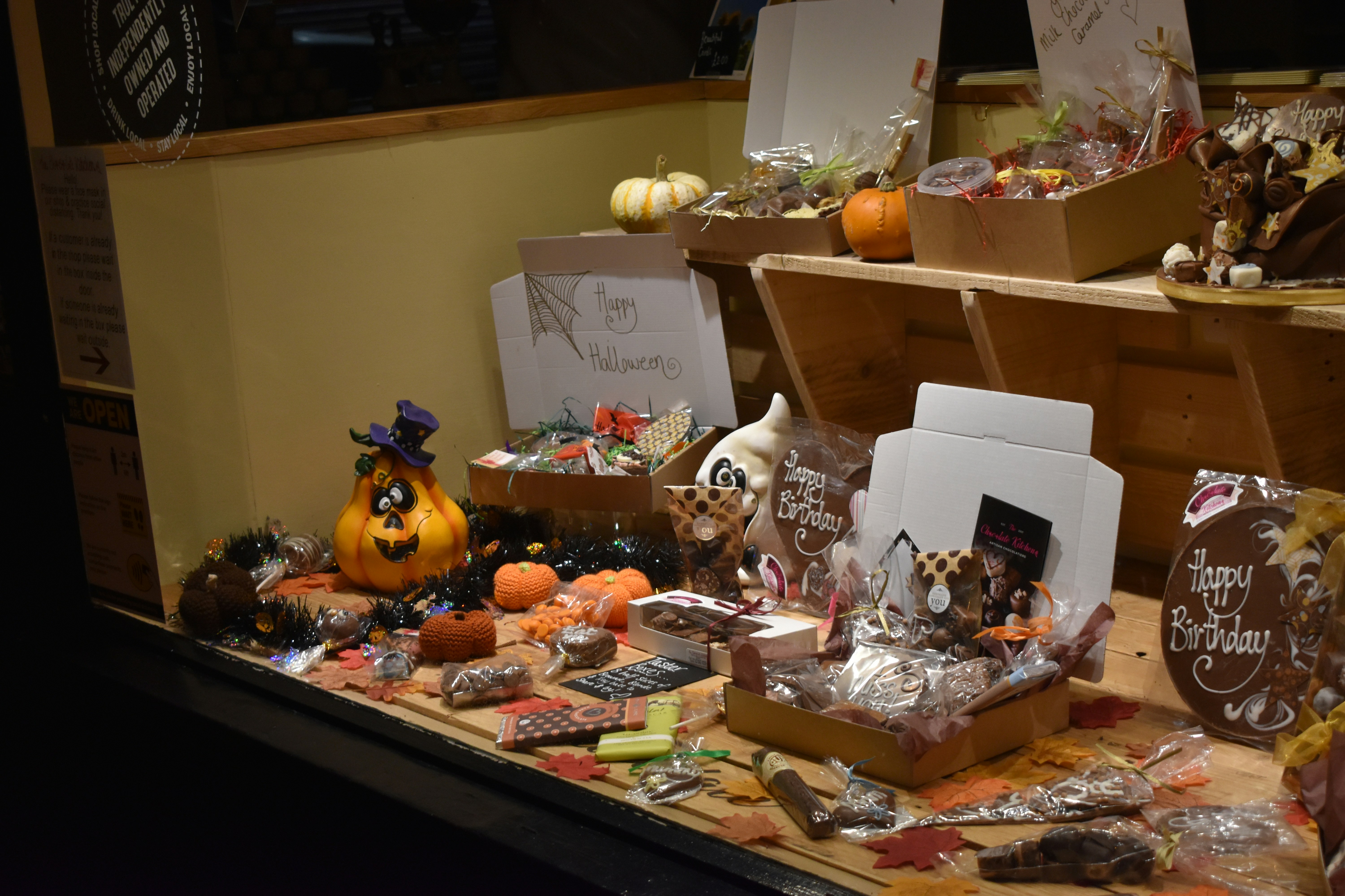 Pumpkin Lanterns and Spooky Treats in a Cozy Shop Window