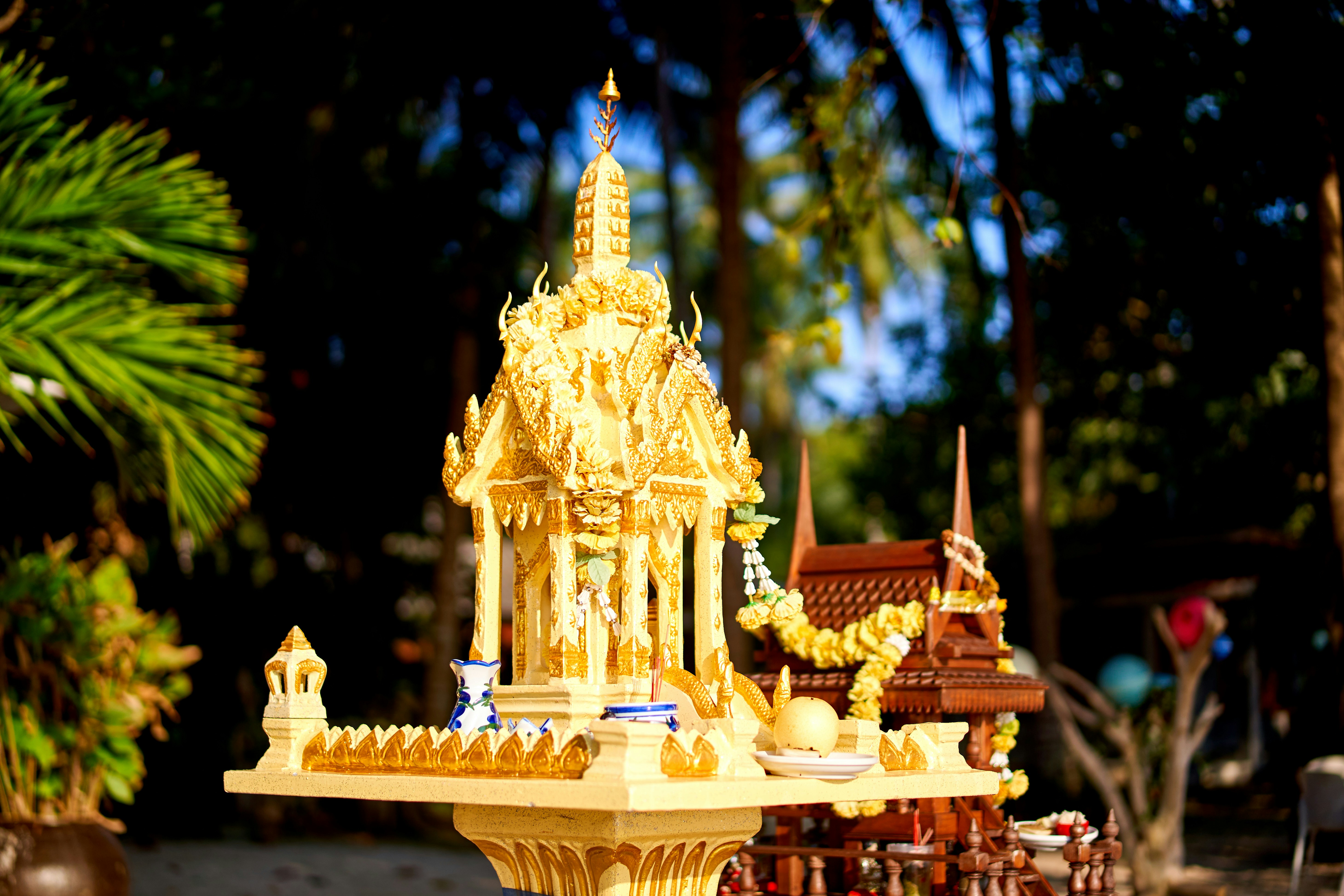 Golden Shrine on a Pedestal: Sunlit Ornaments in a Quiet Garden