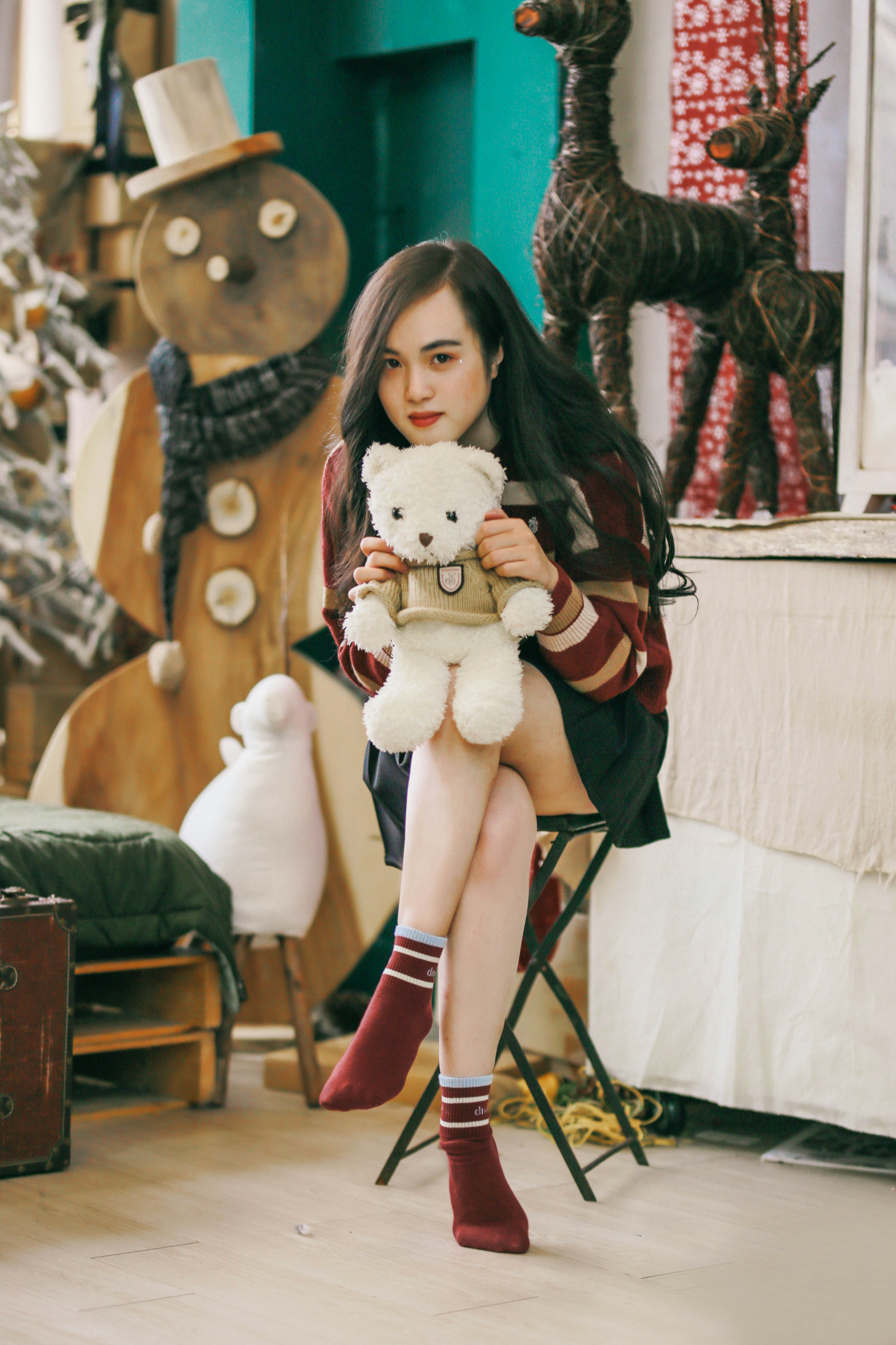 Cozy Christmas Studio: A Girl with a Plush Amid Whimsical Reindeer DecorANNIE HATUANH