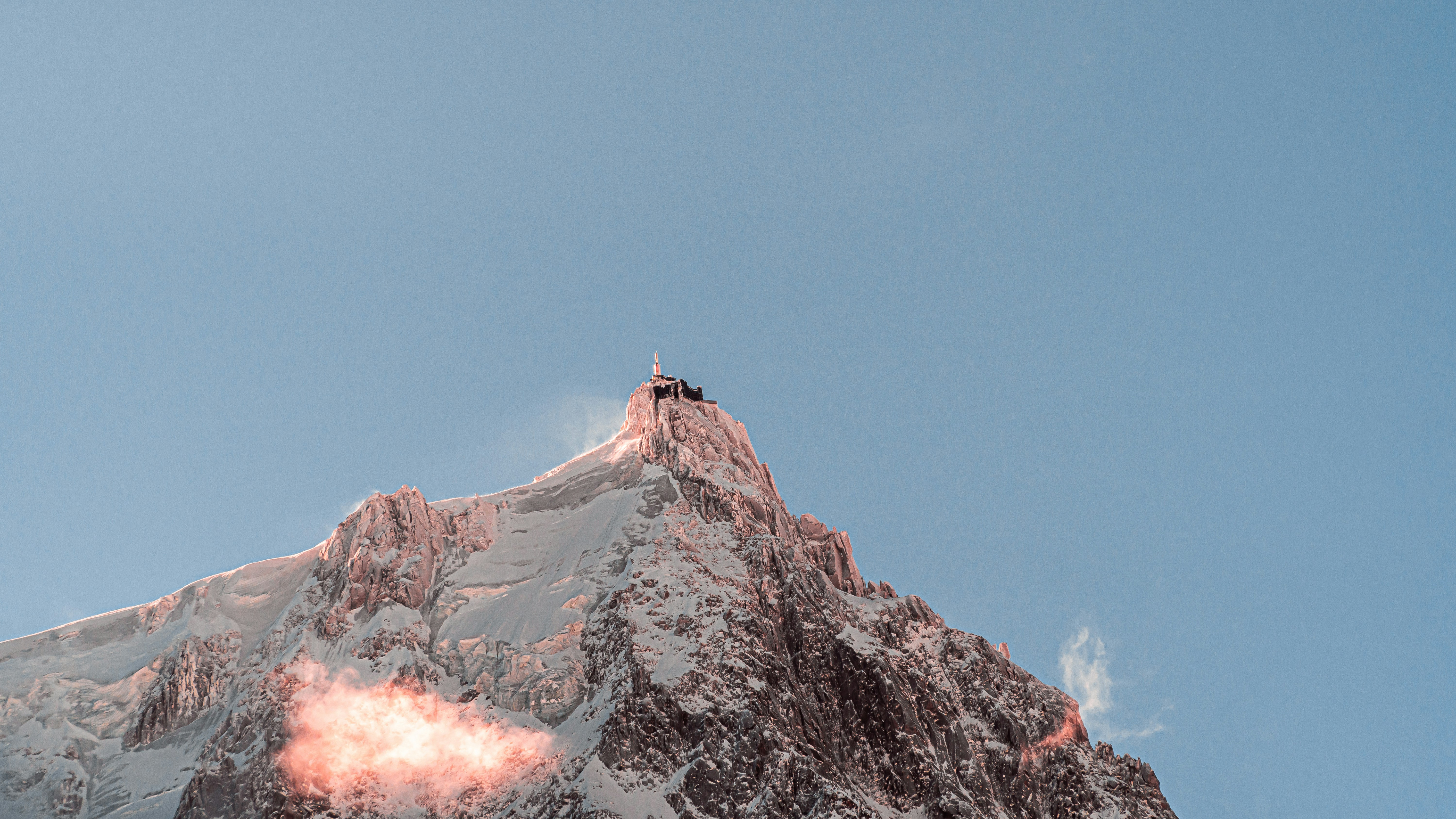 person standing on top of mountain during daytime