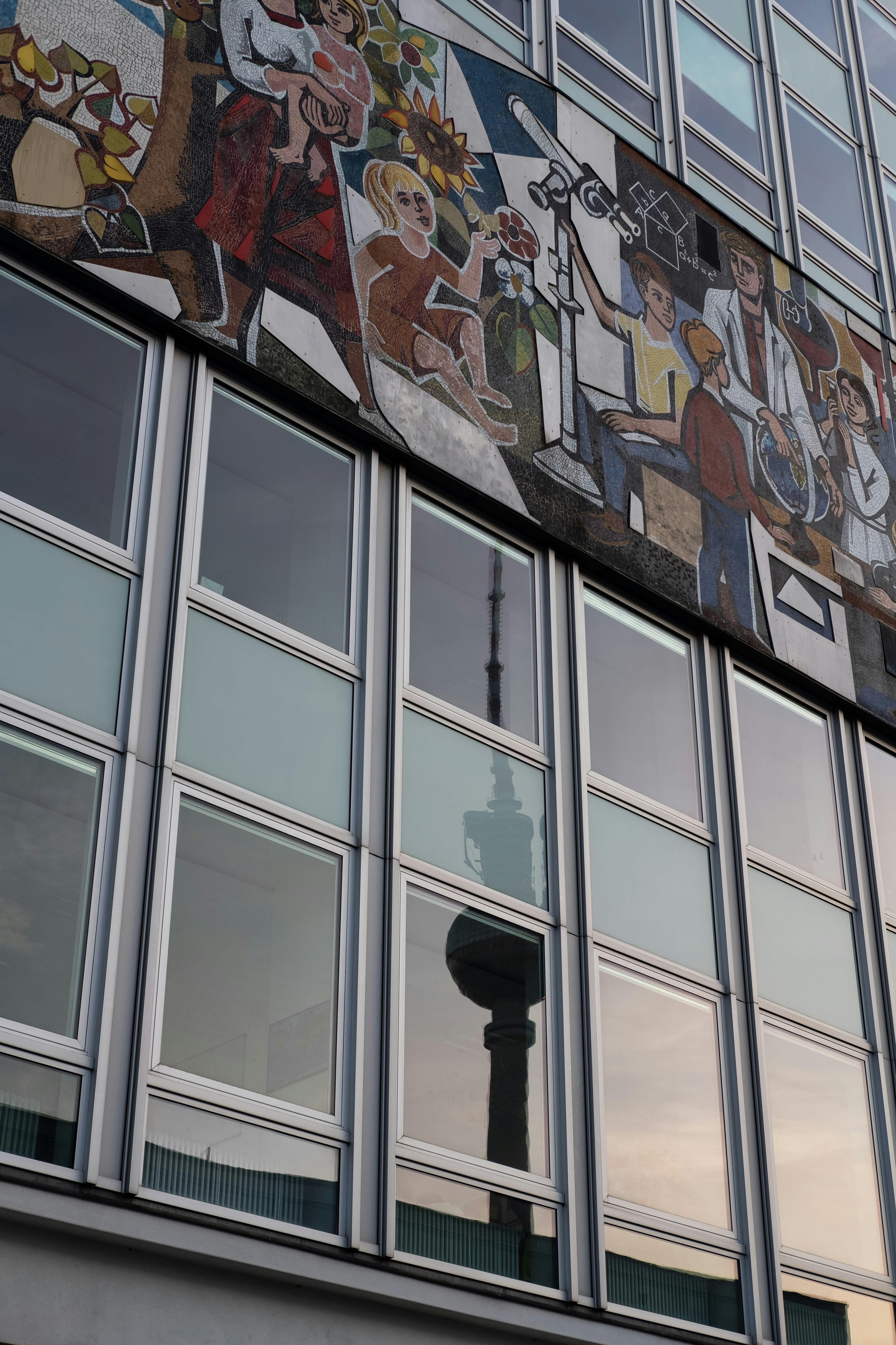 Reflections and mural: windows frame a distant tower
