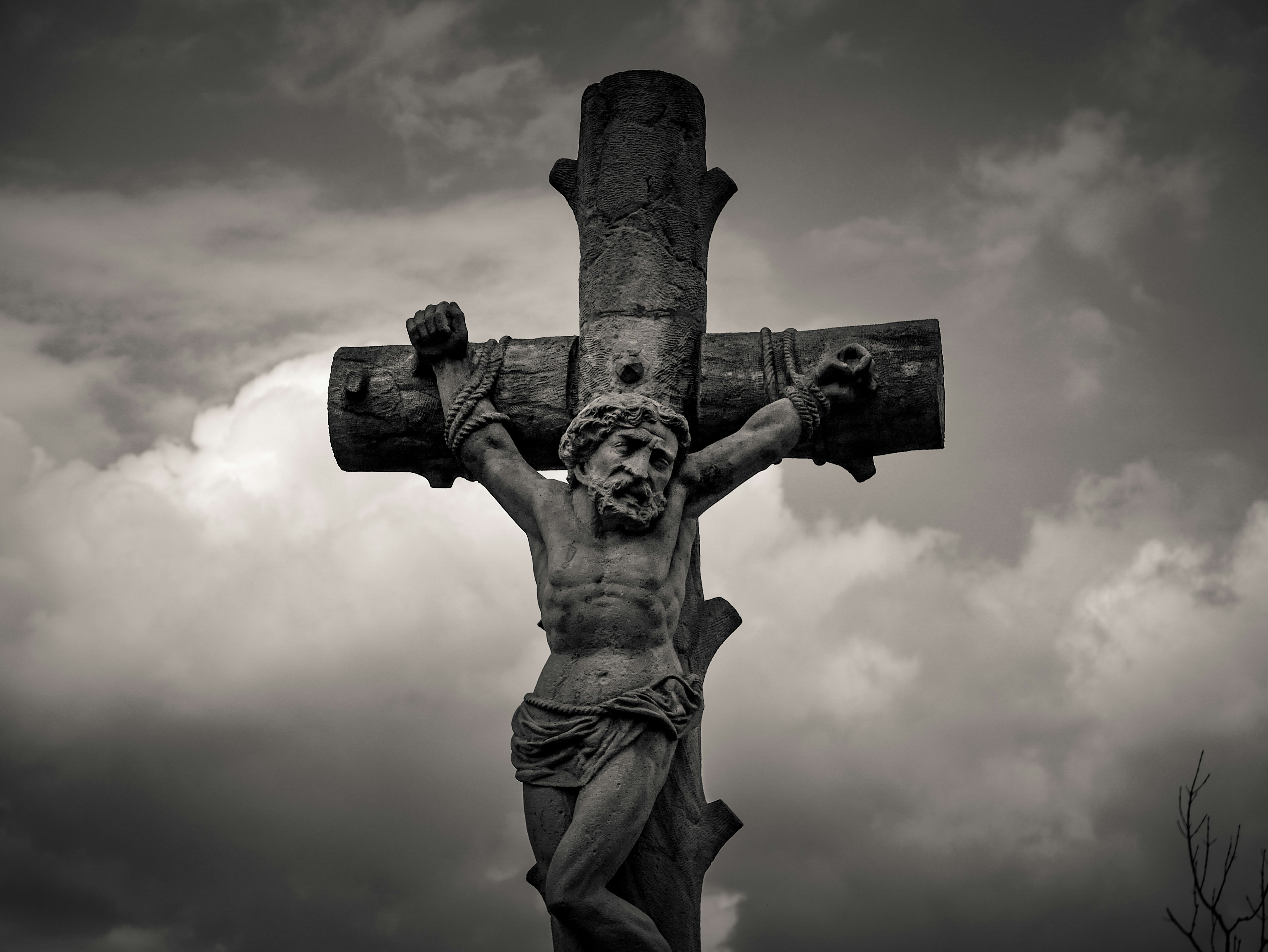 Grayscale photo of man holding cross statue photo – Free Cross Image on ...
