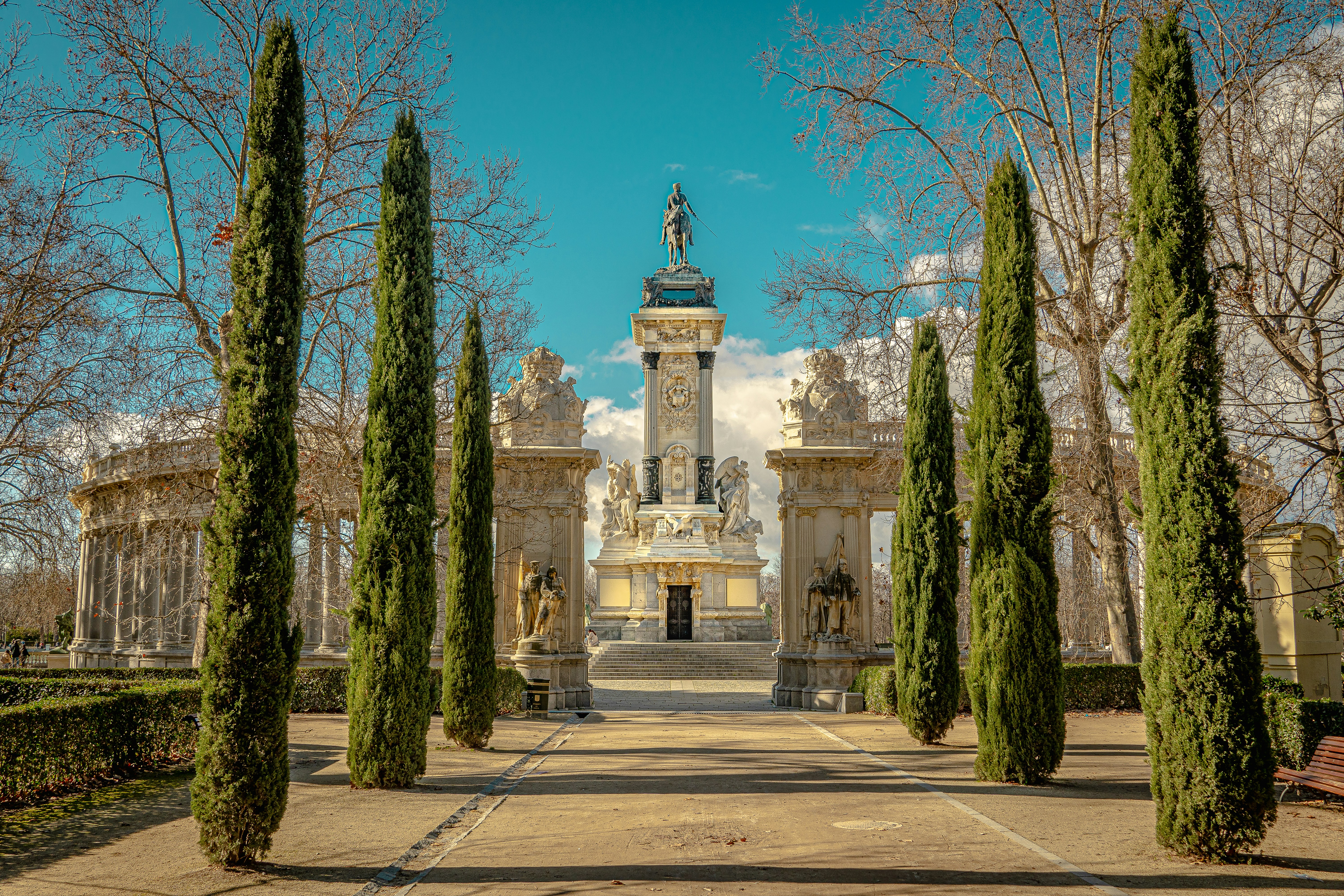Axial Elegance: Monument Framed by Cypress Columns
