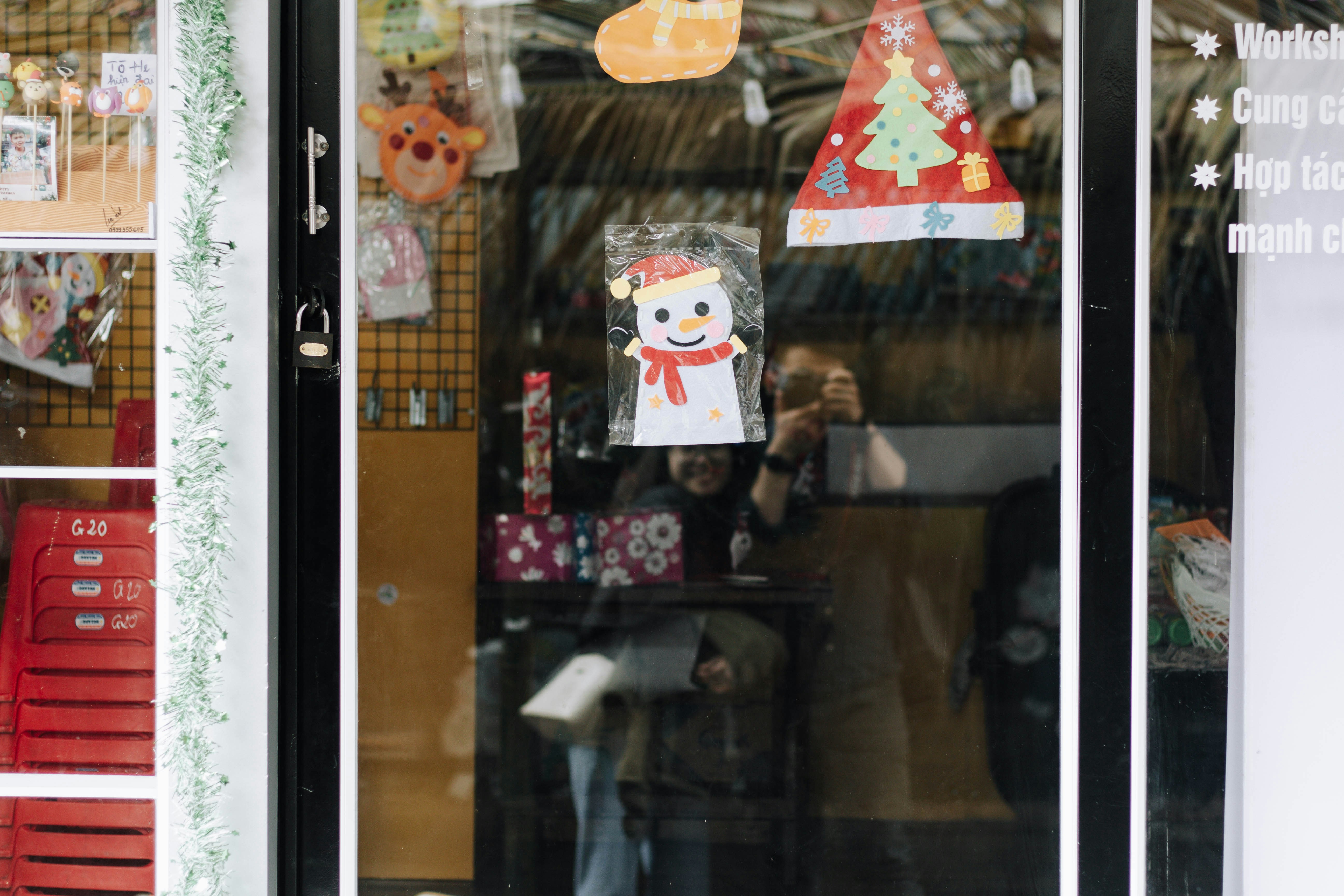 Snowman Sticker in the Window: Festive Shopfront Portrait
