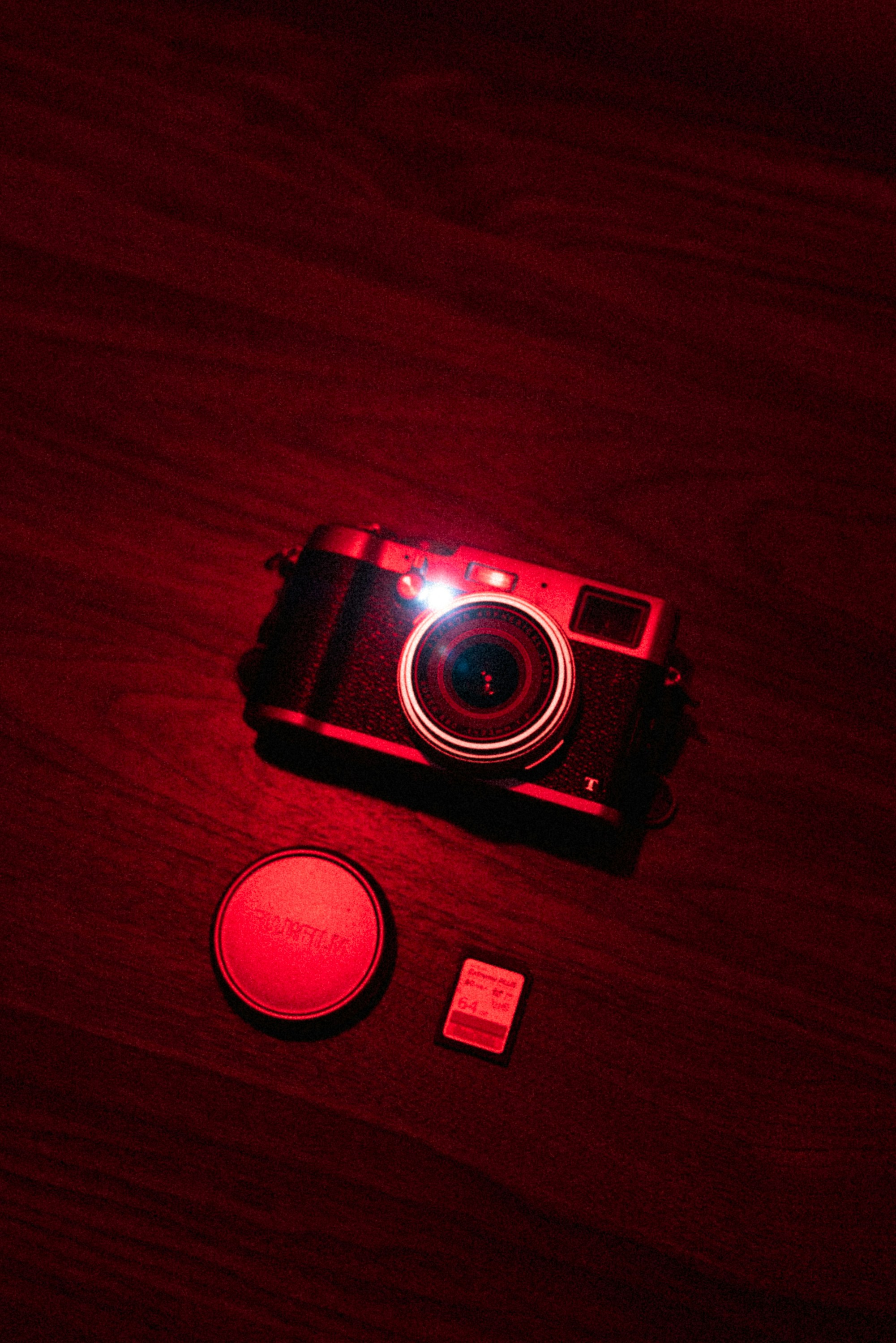 black and silver camera on brown wooden table