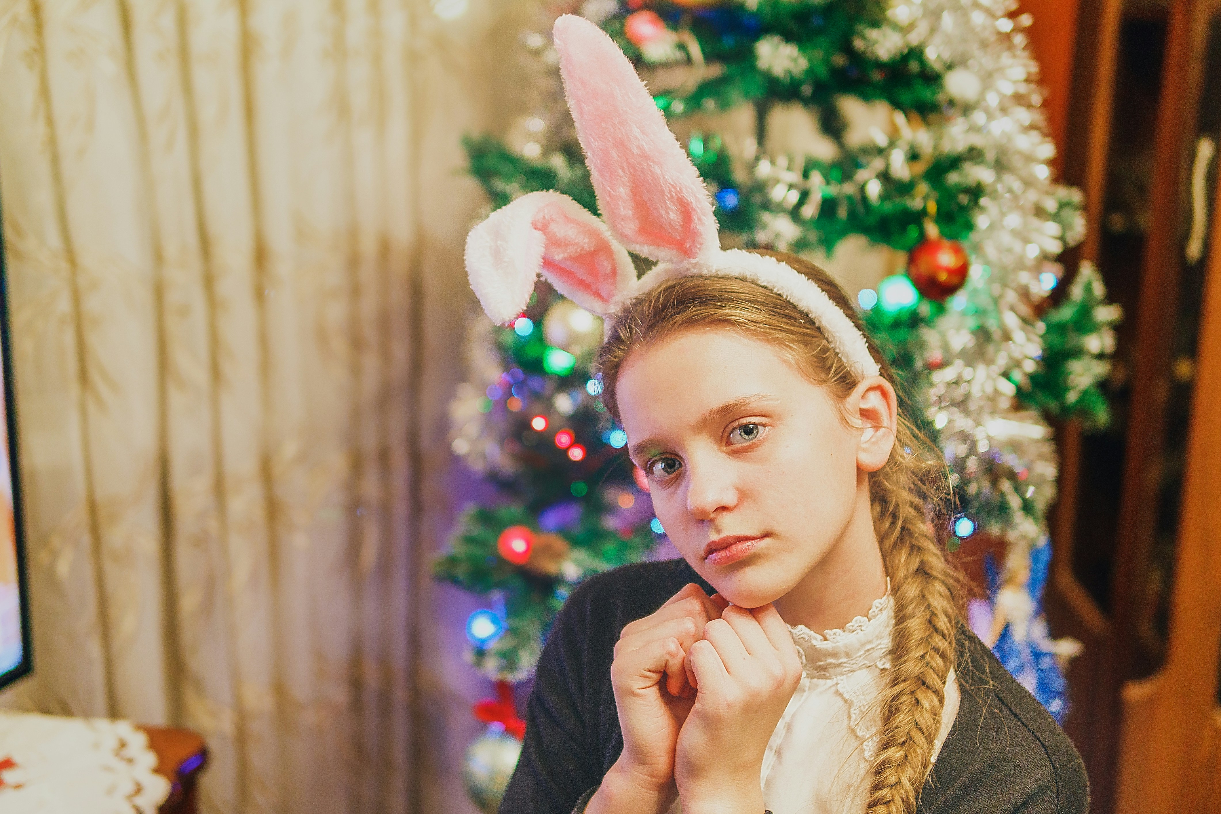 Bunny-Eared Quietude: A Portrait Amid Holiday Lights
