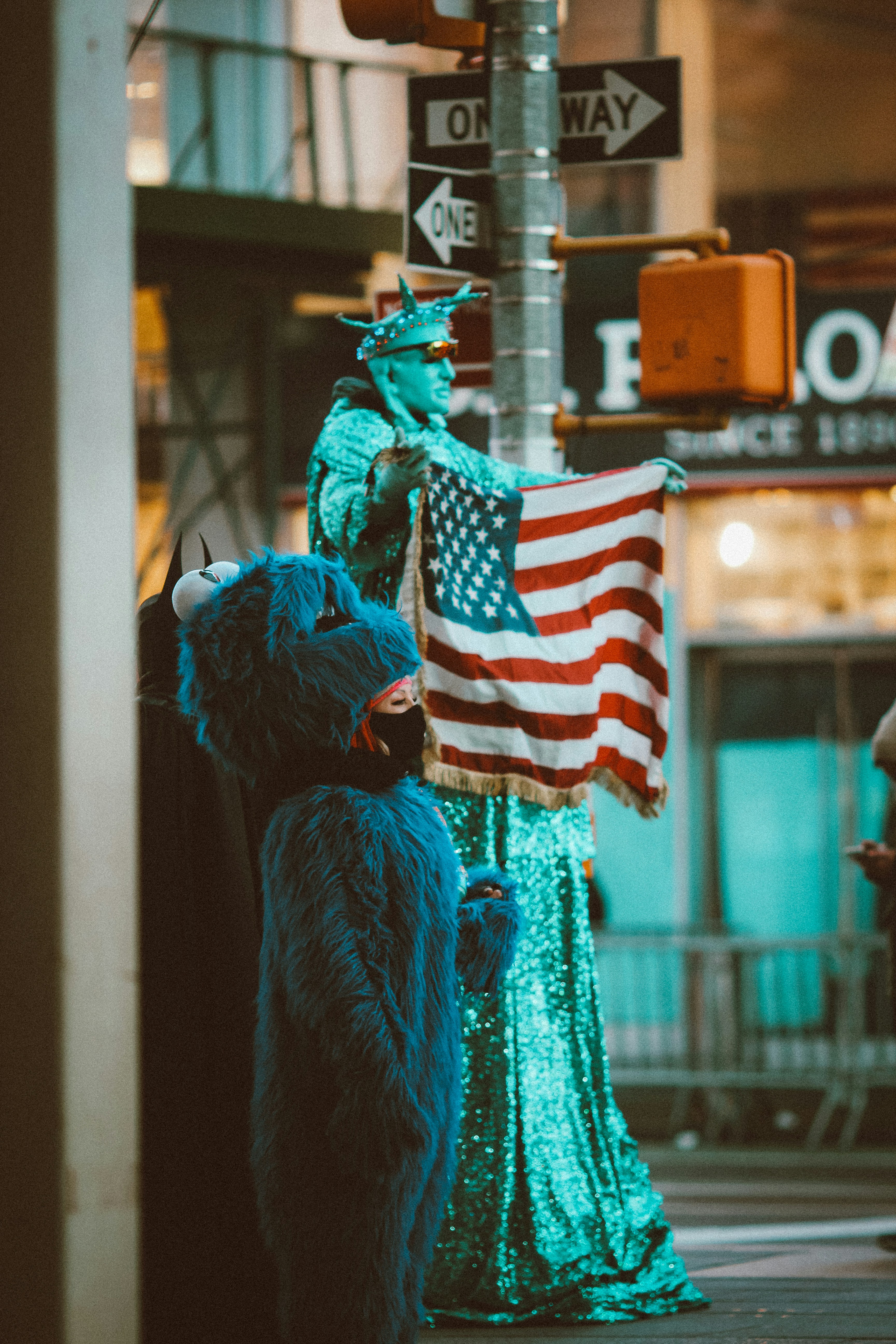 Flag Bearer in Turquoise Light: A Street Parade of Masks and Neon