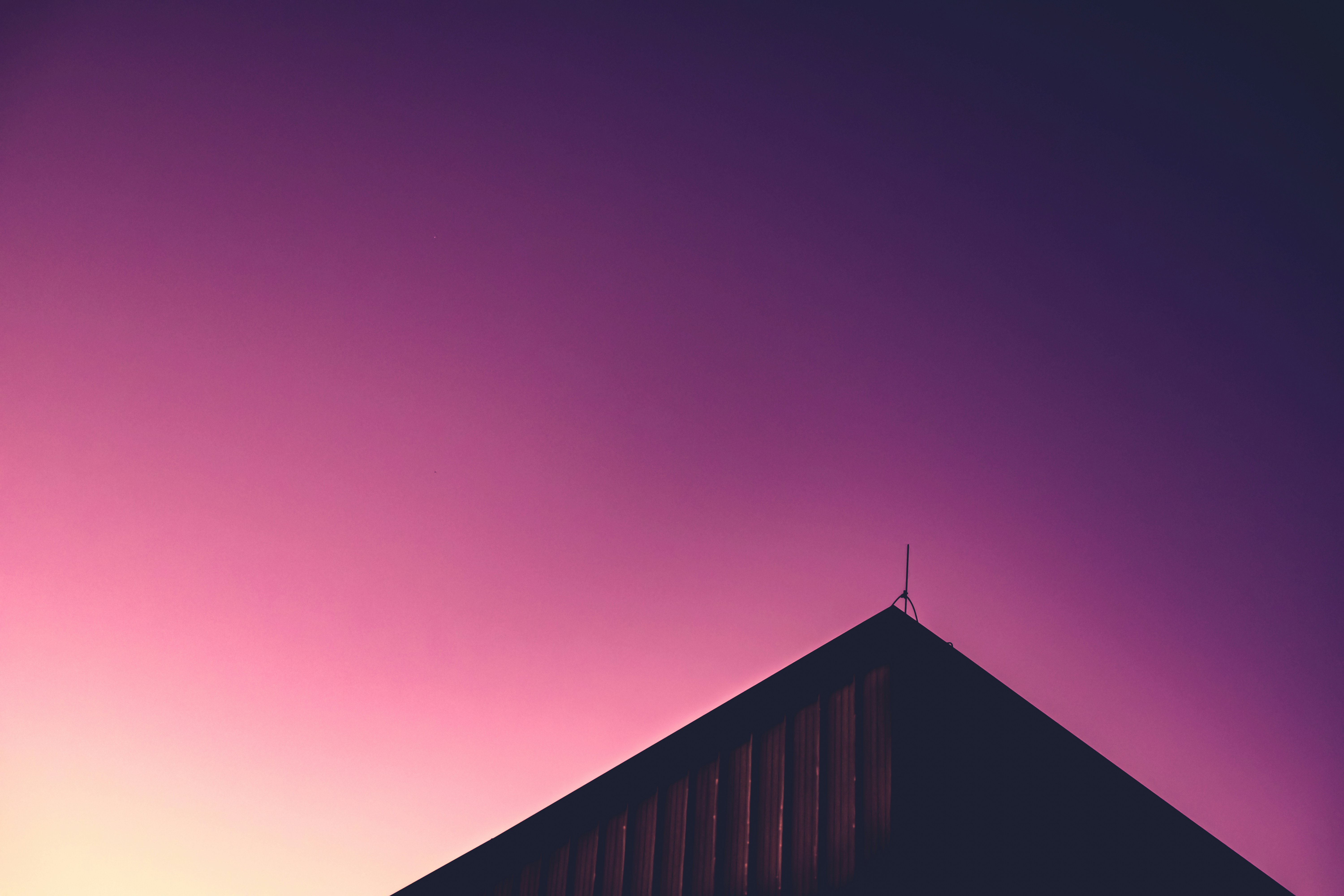Ridge of Nightfall: Rooftop Silhouette Under a Sunset Gradient