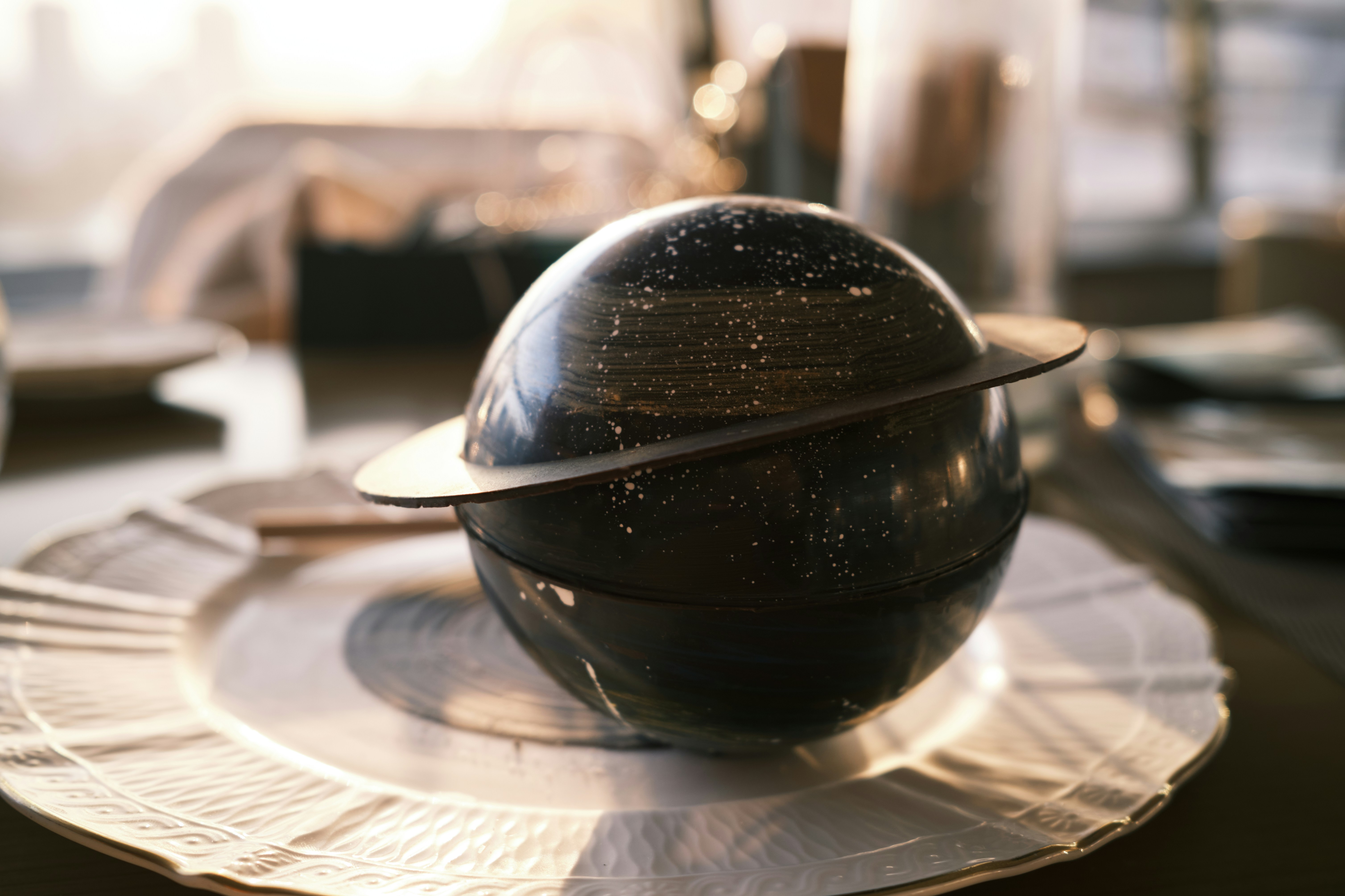 Orbital Centerpiece: A Glimmering Globe on a Ruffled Plate