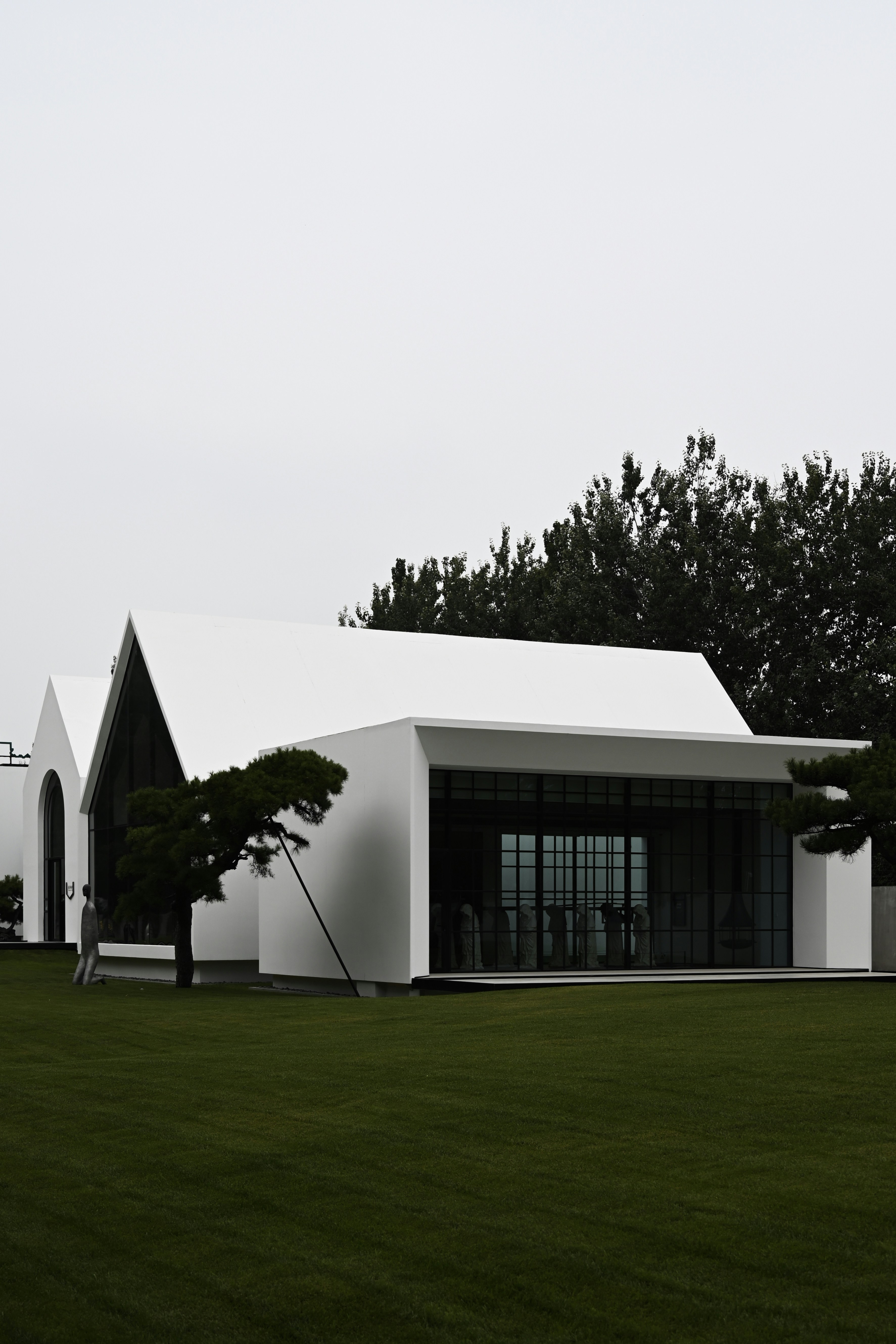Minimalist White Pavilion Against Stormy Sky