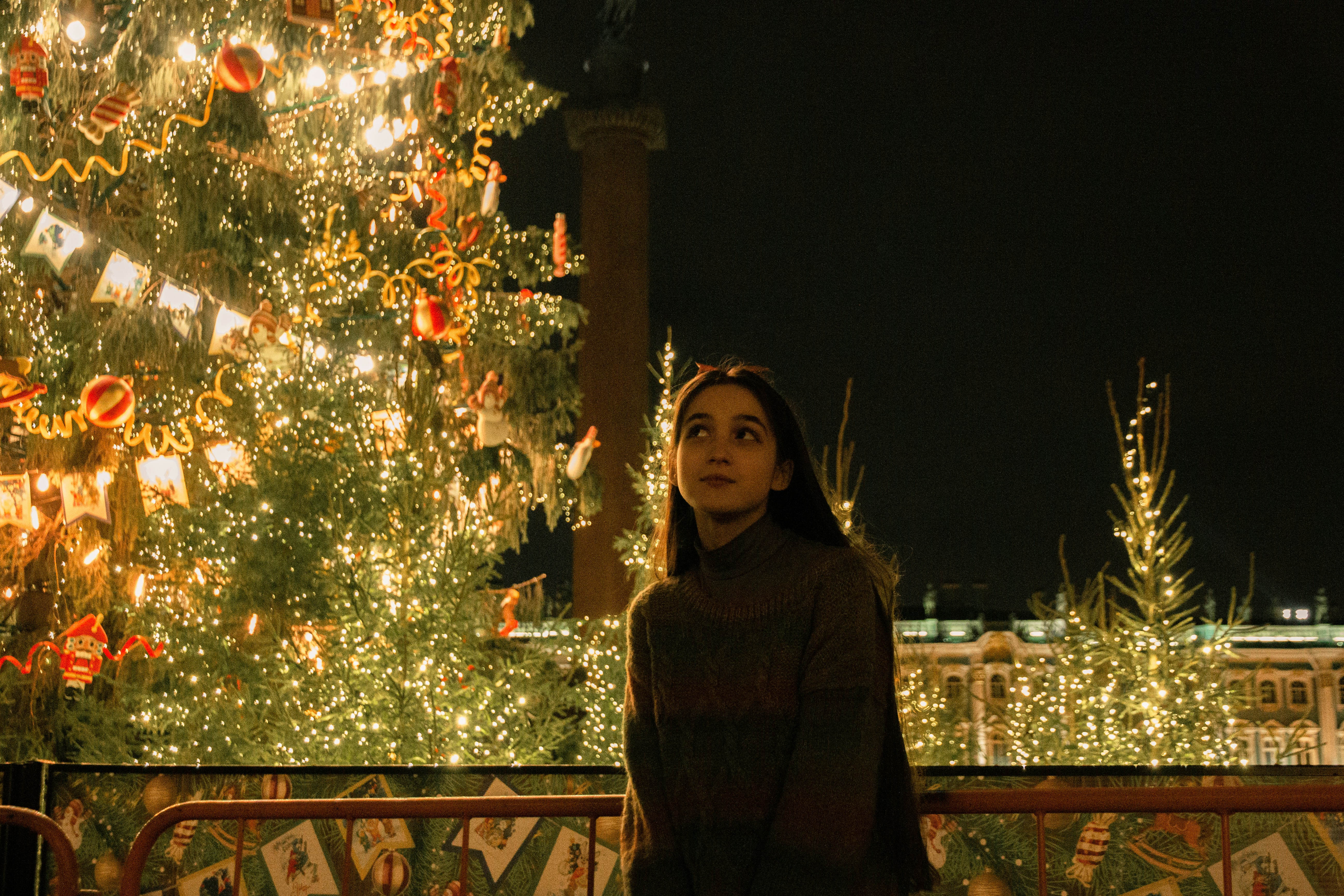 Under the Holiday Glow: A Portrait Beneath a Cascade of Christmas Lights