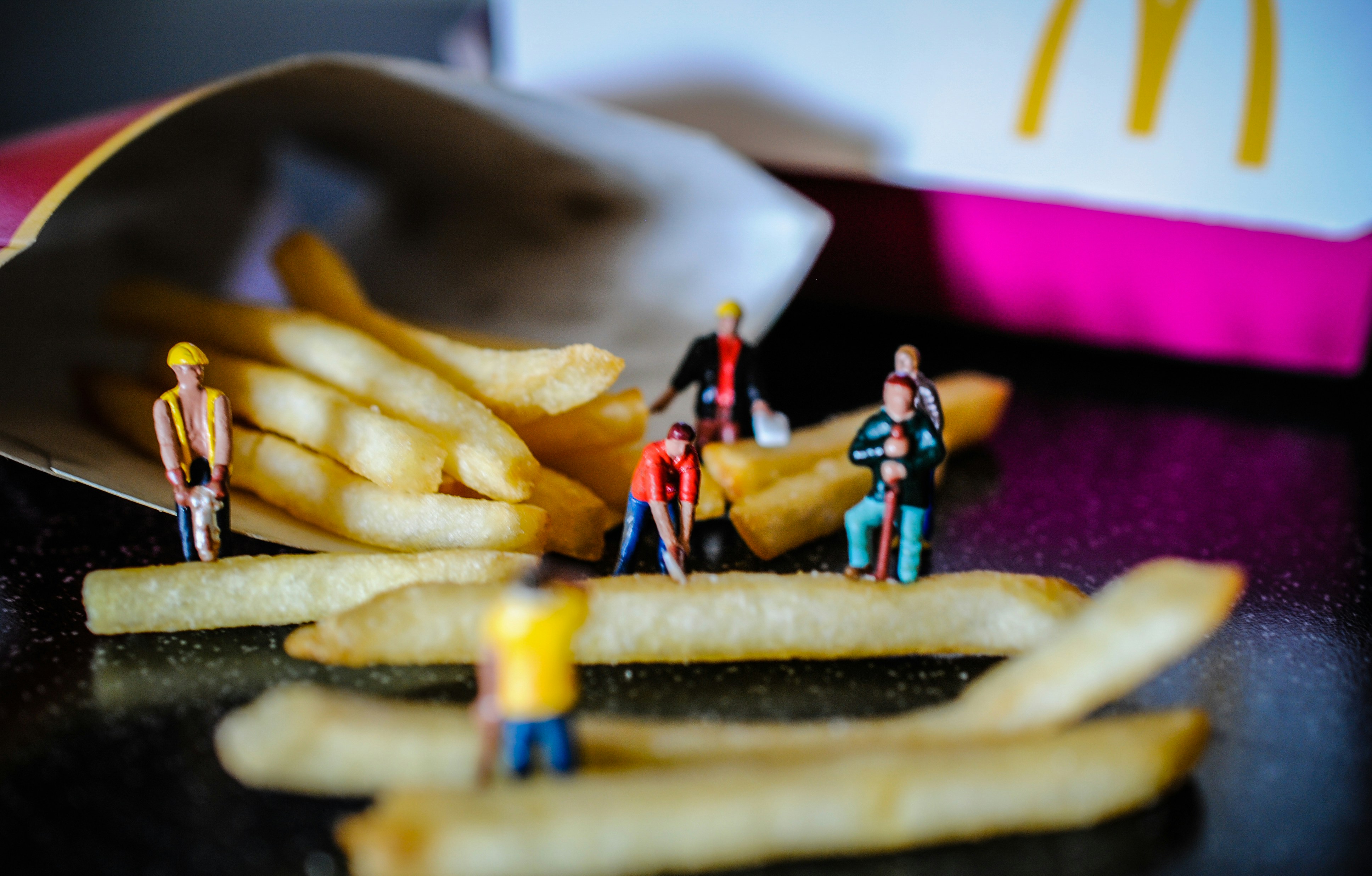 Miniature workers, working in McDs french fries 