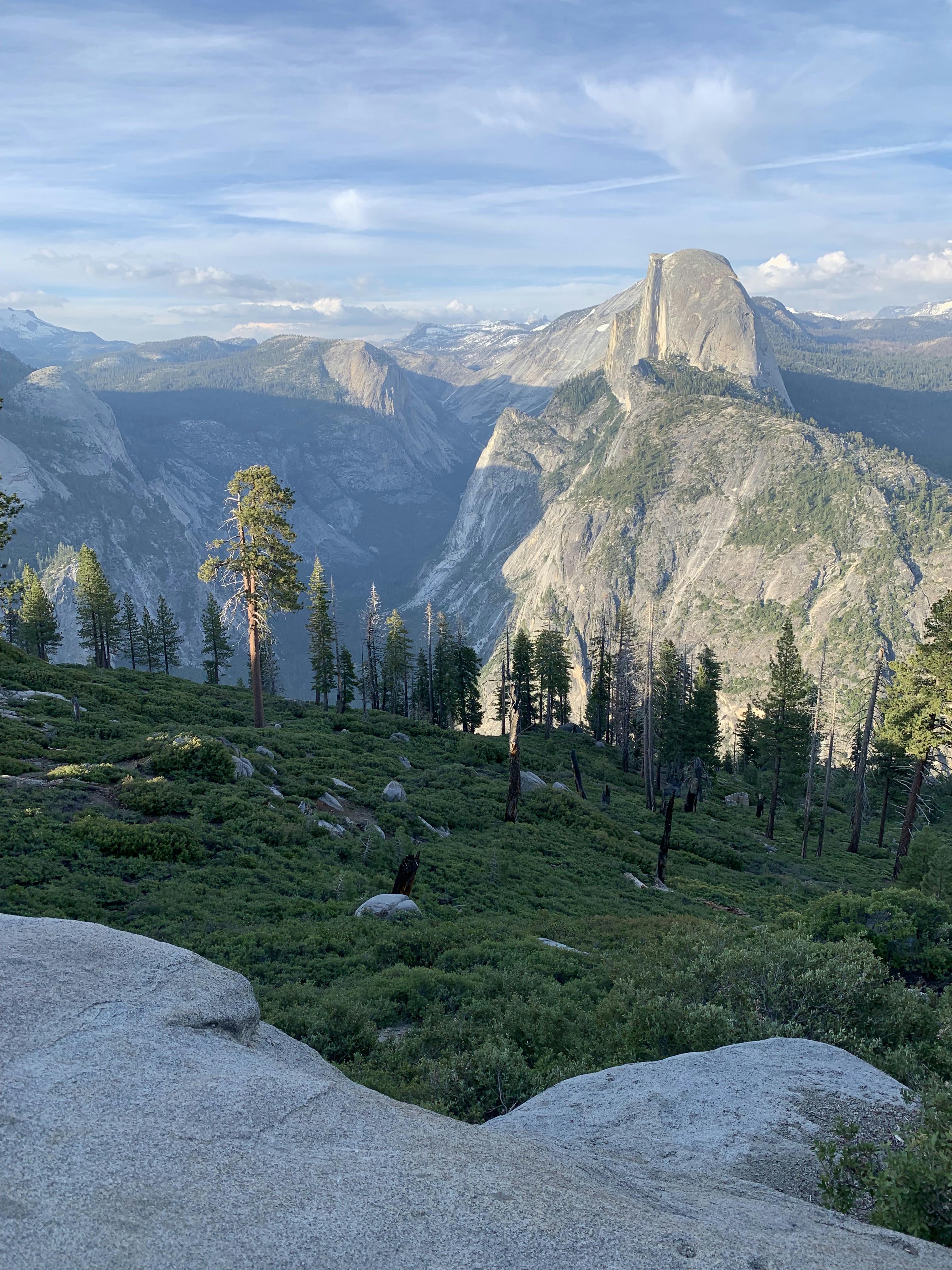 Granite Dome Crowned by Sunlight Over Pine-Covered Ridge