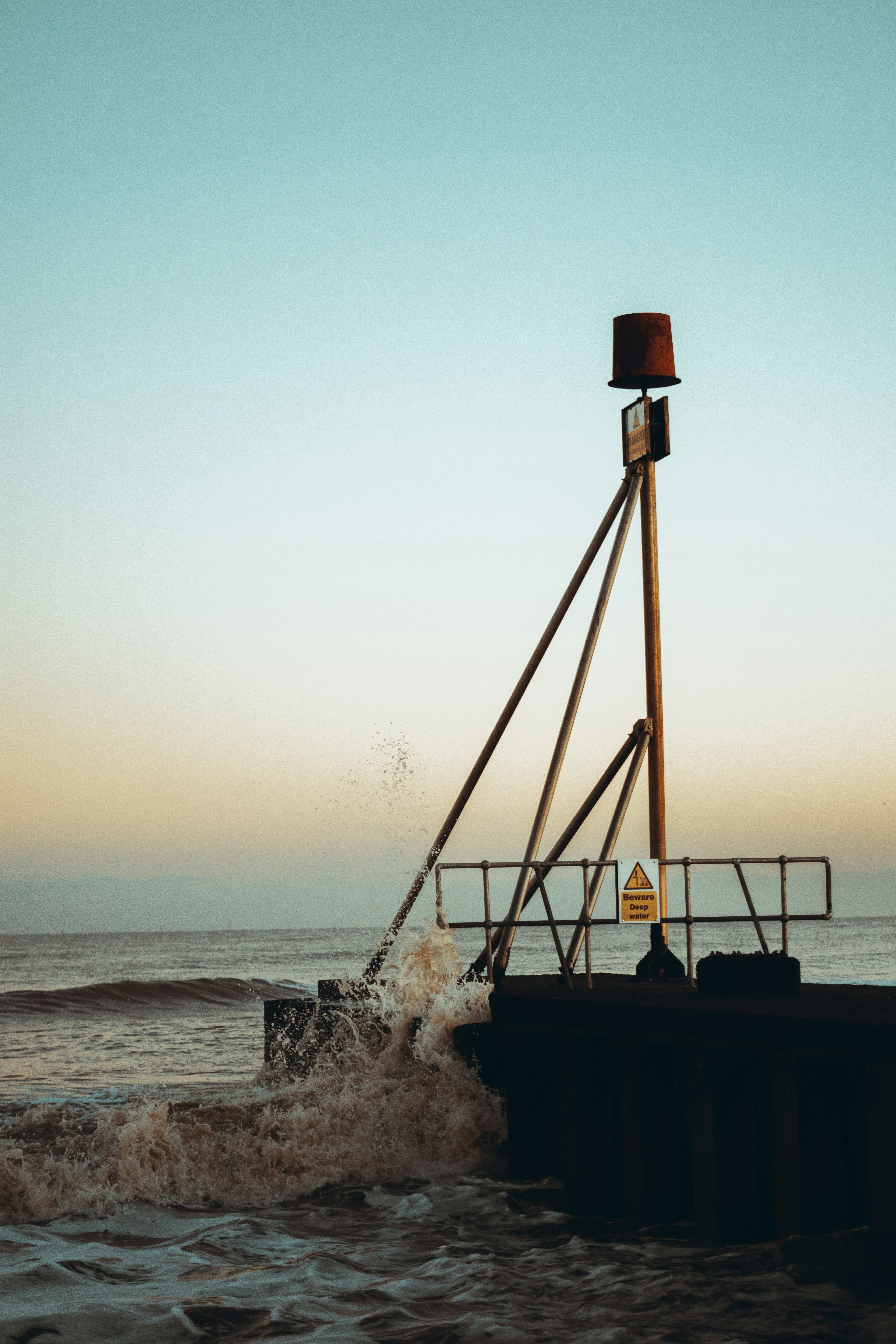 Distant Signal: A Seaside Pier's Wave-Kissed Sentinel