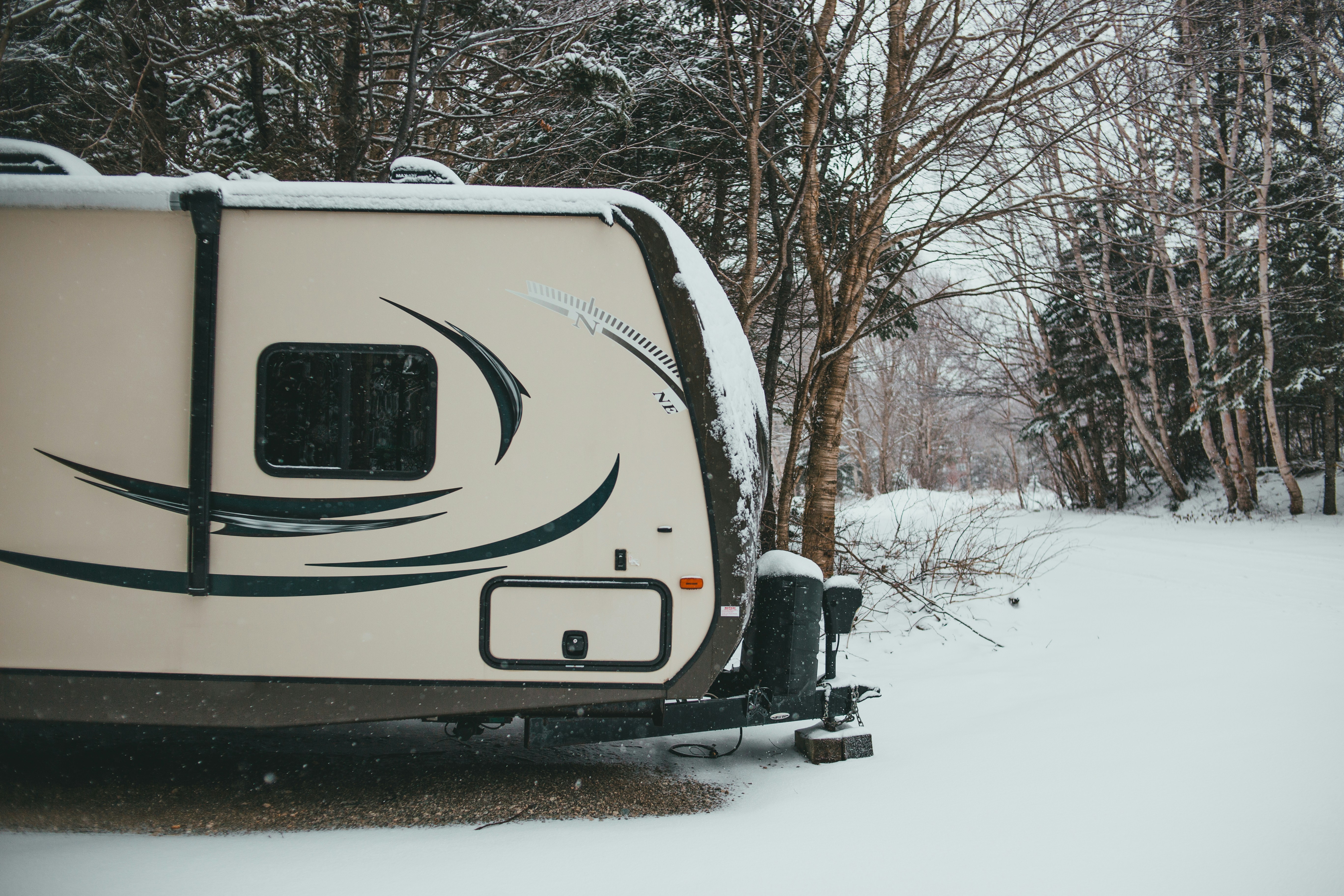White and black rv trailer on snow covered ground photo – Free Grey ...