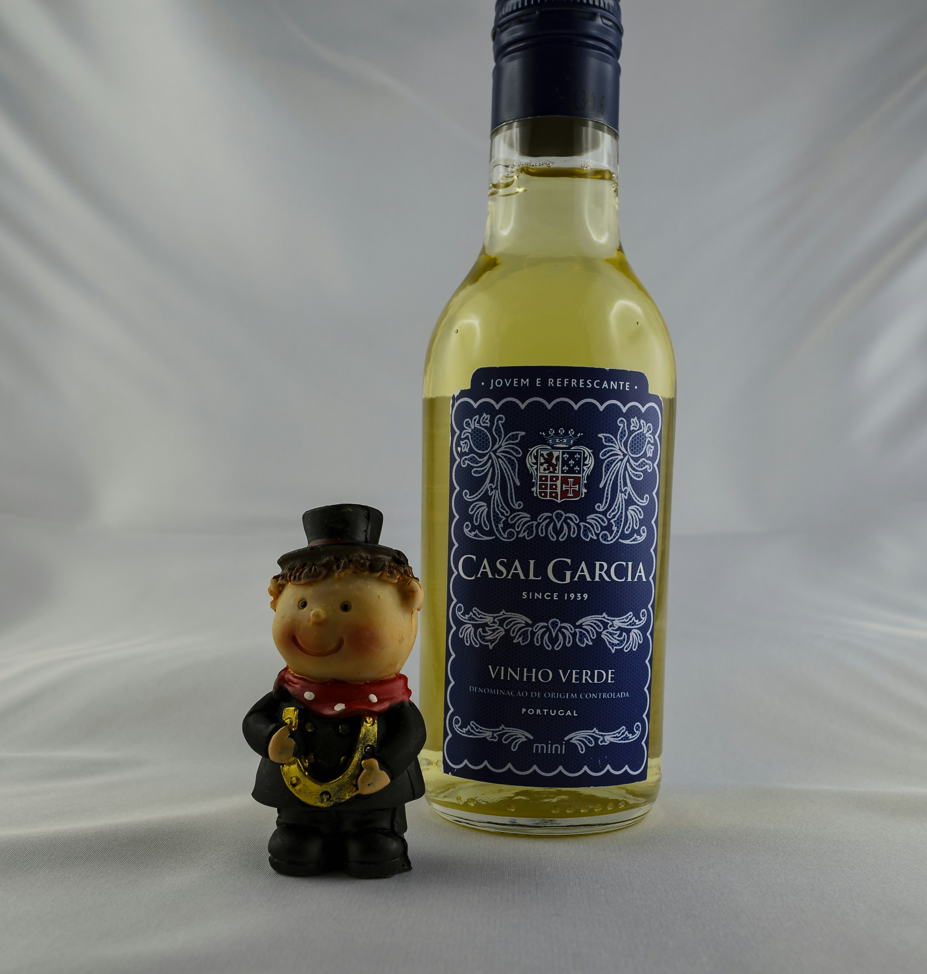 Label and Little Luminary: Casal Garcia Vinho Verde Beside a Cheerful Figurine
