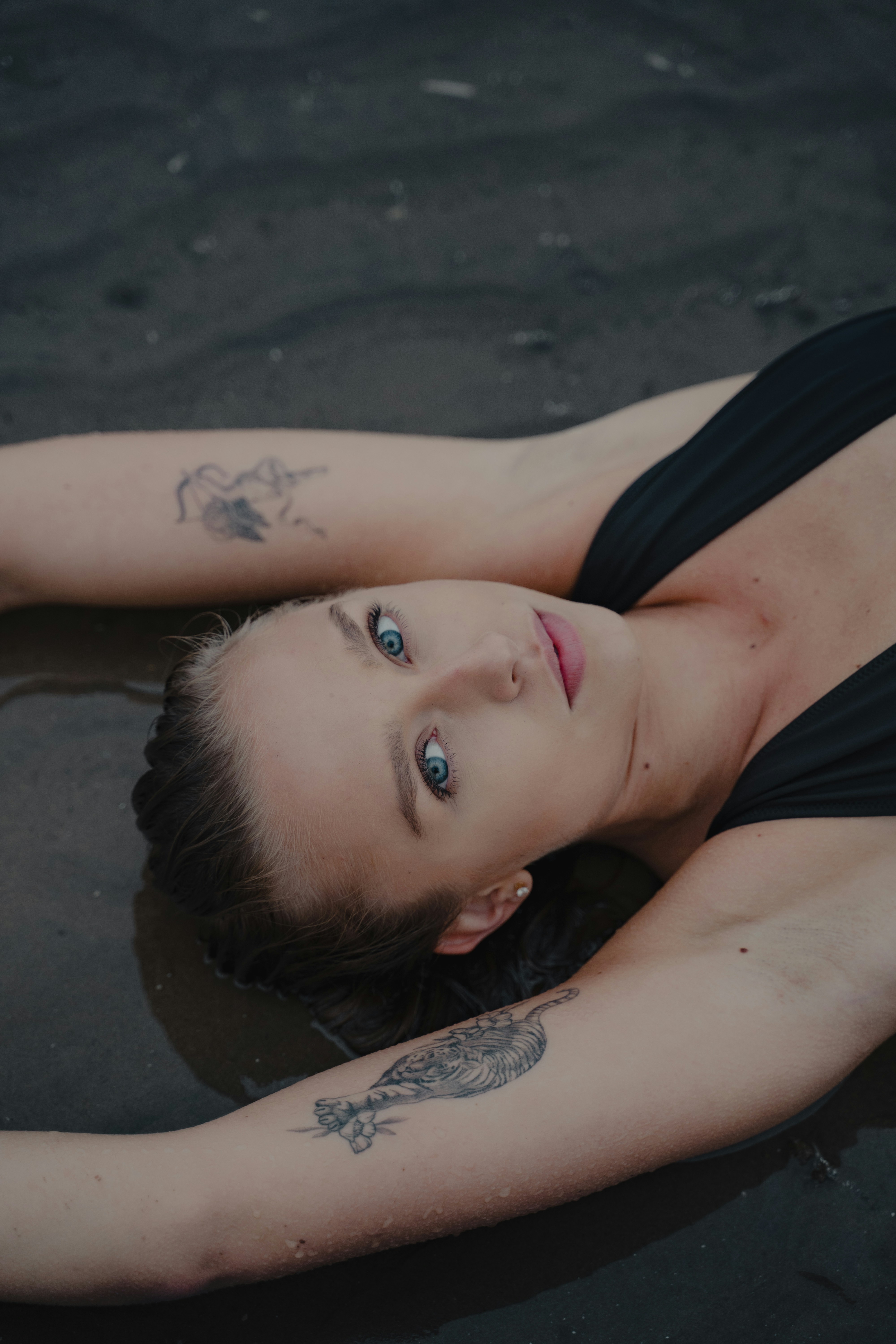 Azure Gaze on Black Sand: A Quiet Beach Portrait
