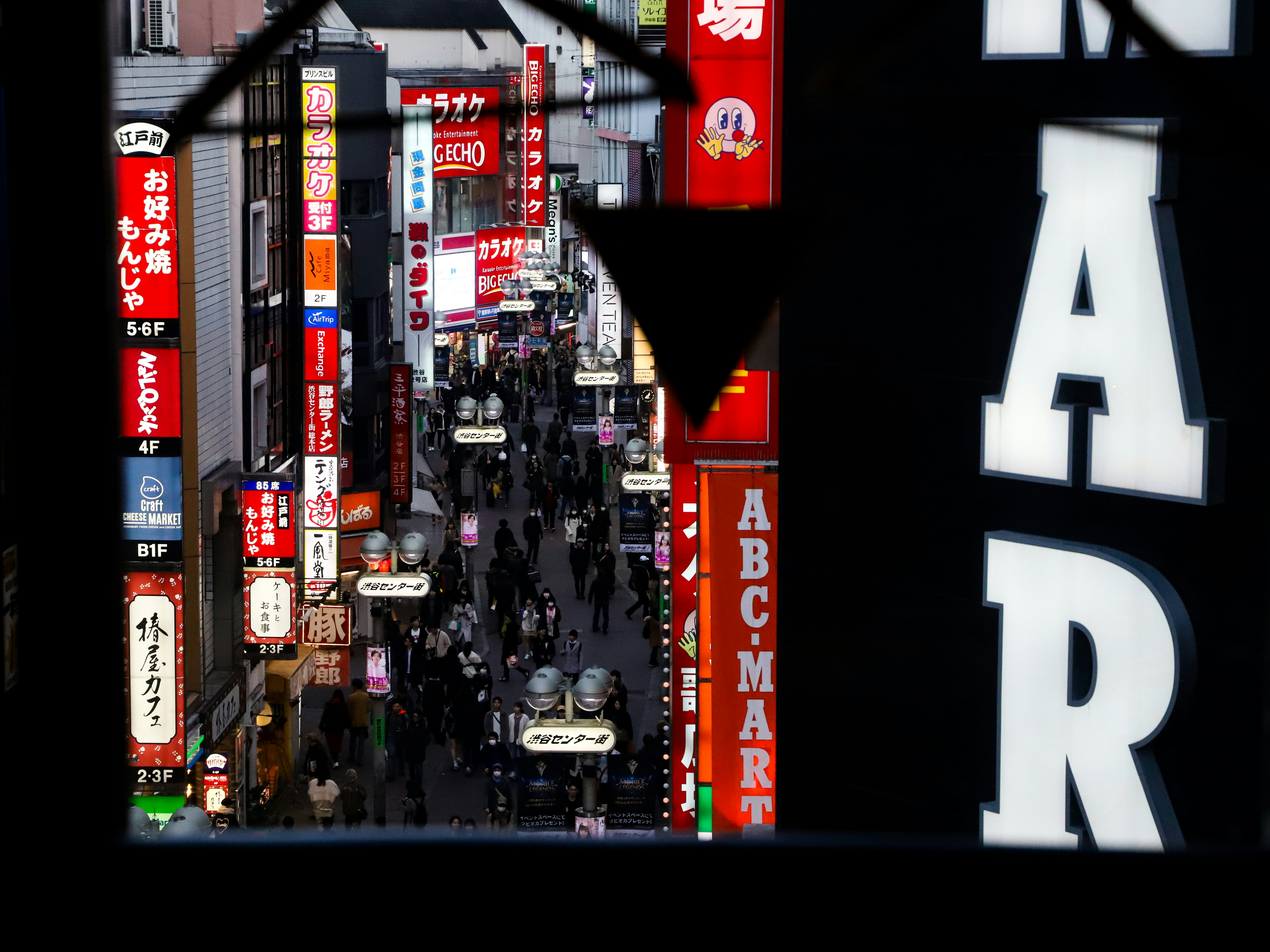 Neon Canyon: Narrow Japanese Street Framed by Giant Signboards