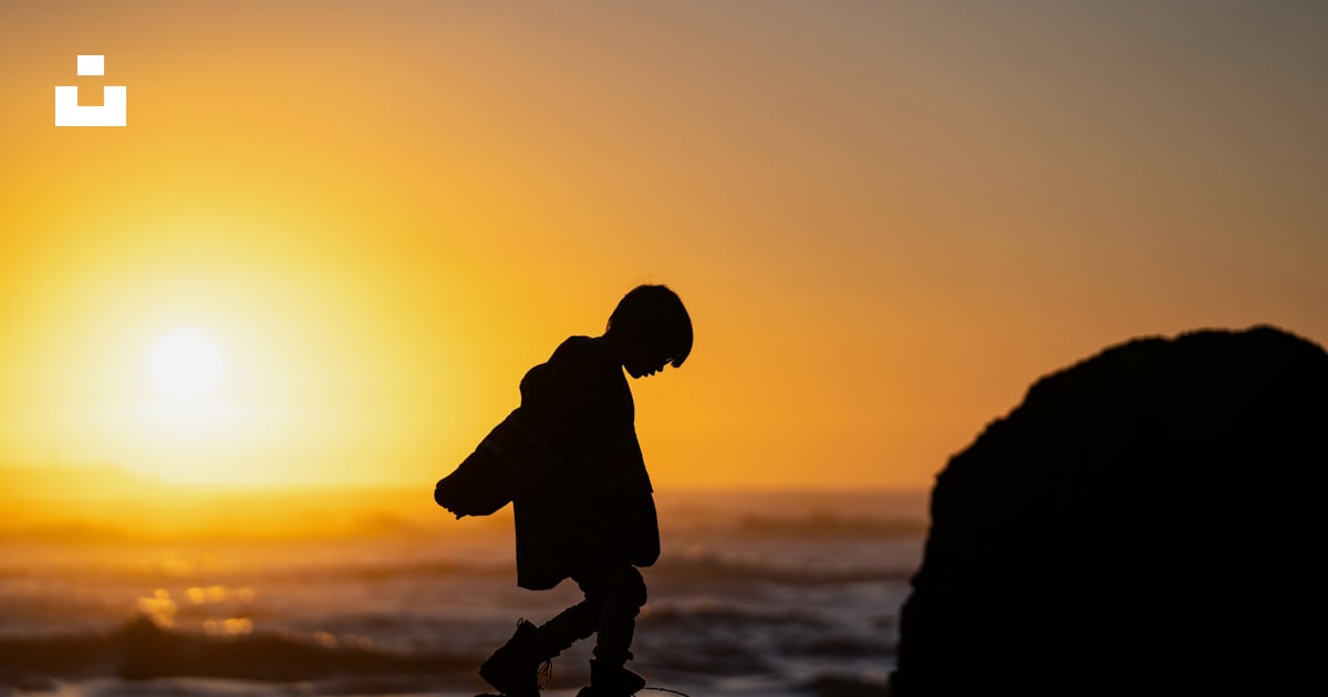 Silueta De Hombre Y Mujer Besándose Durante La Puesta Del Sol Foto