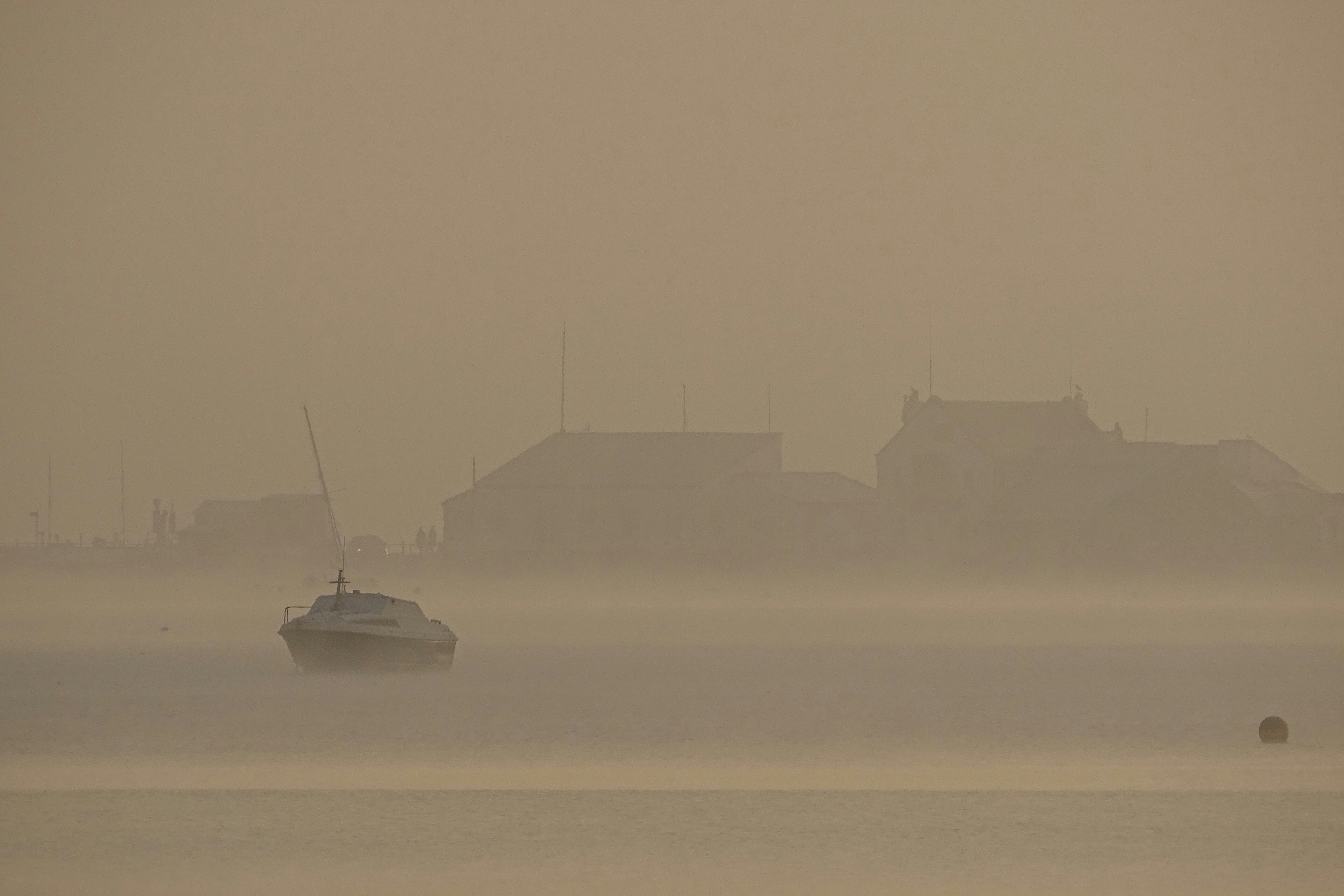 Mist-Laced Harbor: A Silent Boat at Dawn