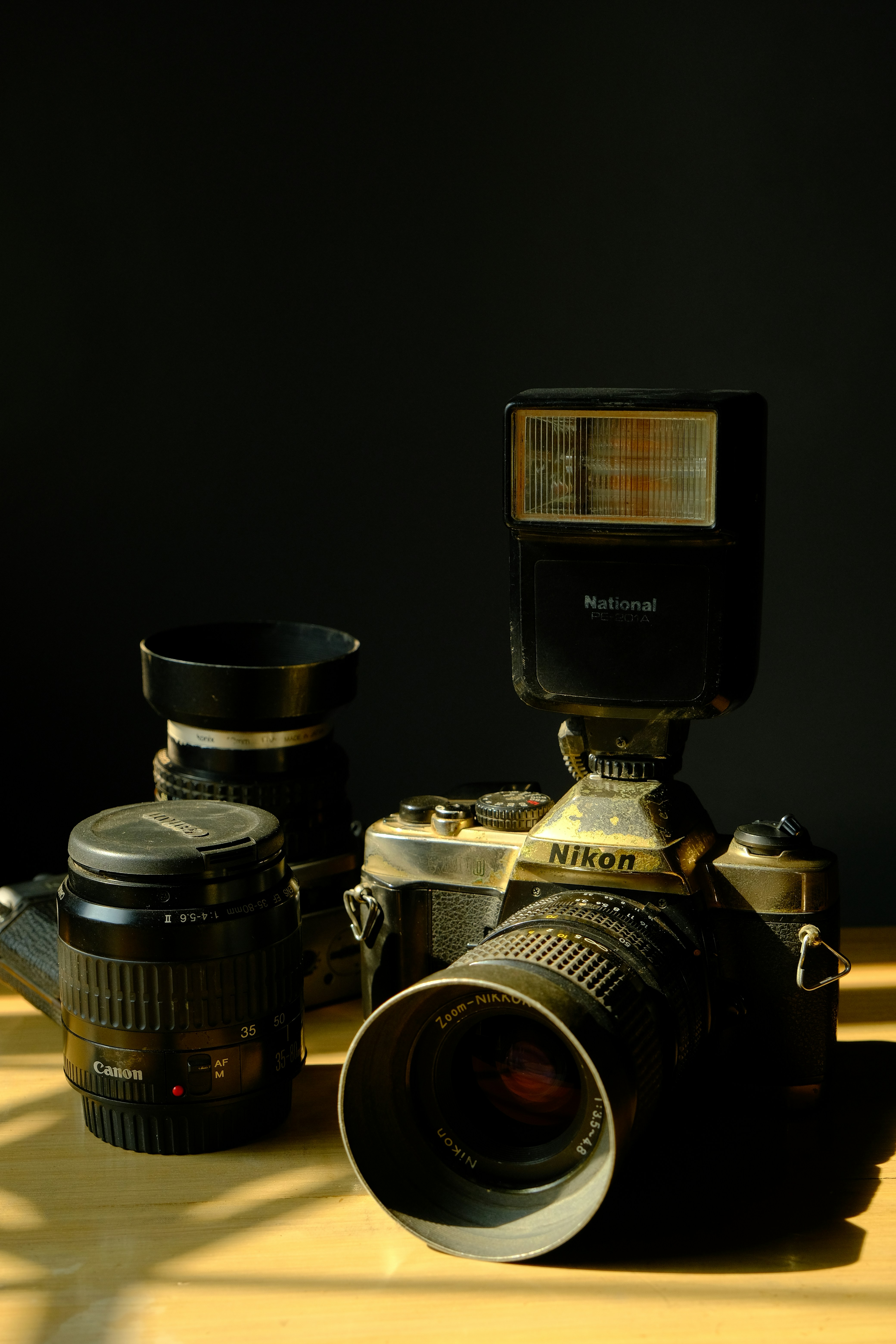 Nikon relic under warm studio light: a still-life of glass and metal