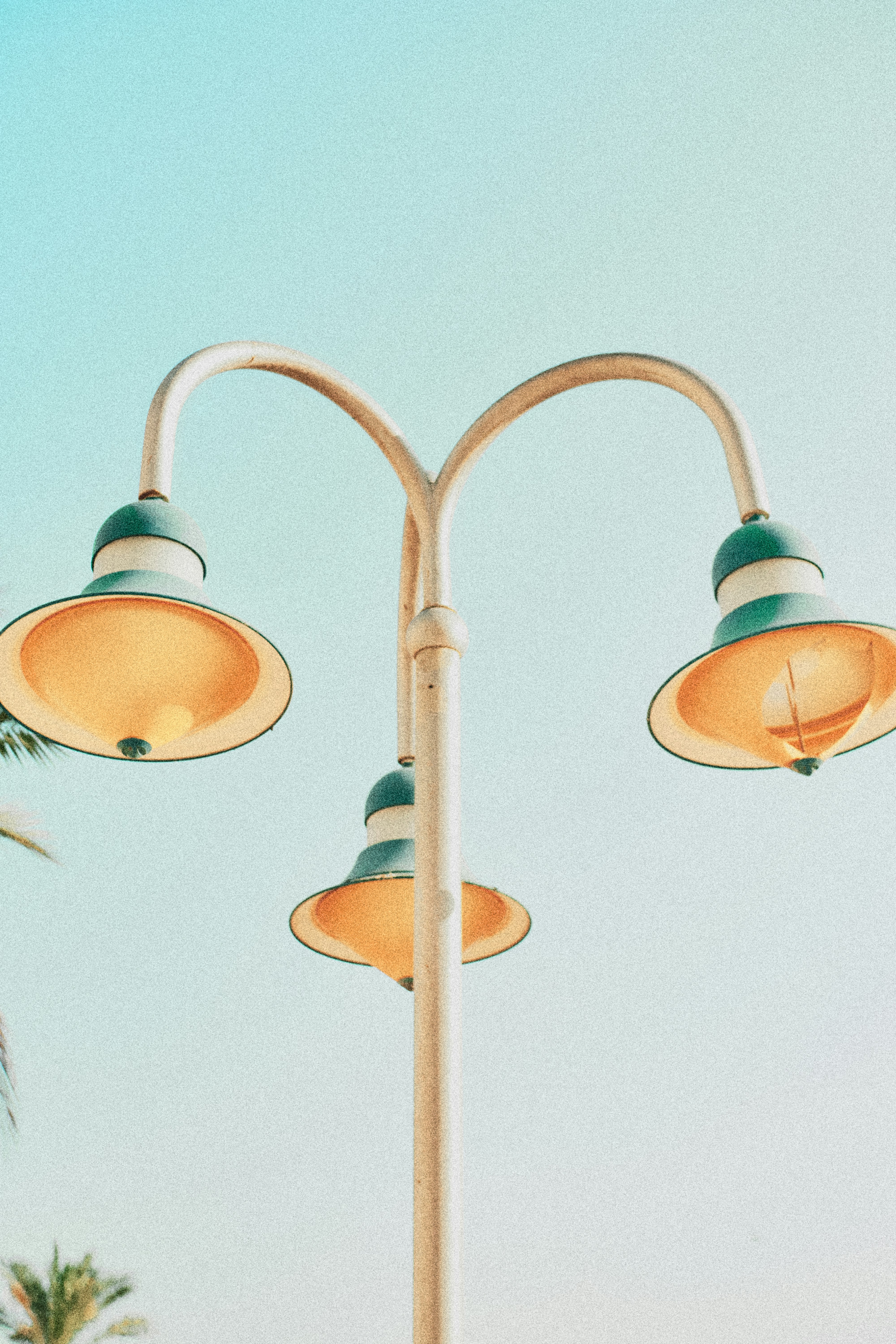 Symmetrical Street Lamp Trio Against a Mint Sky