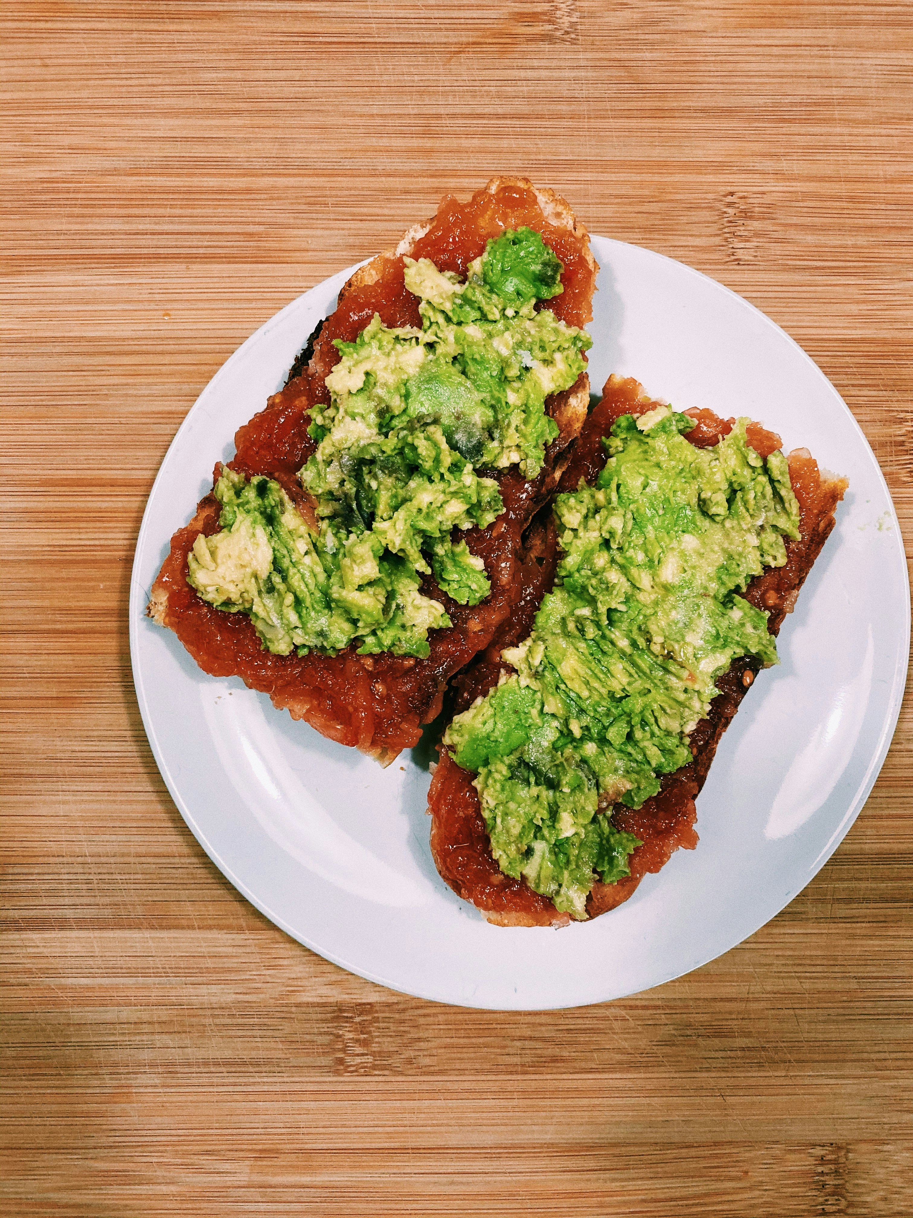 Guacamole-Topped Toasts on a White Plate
