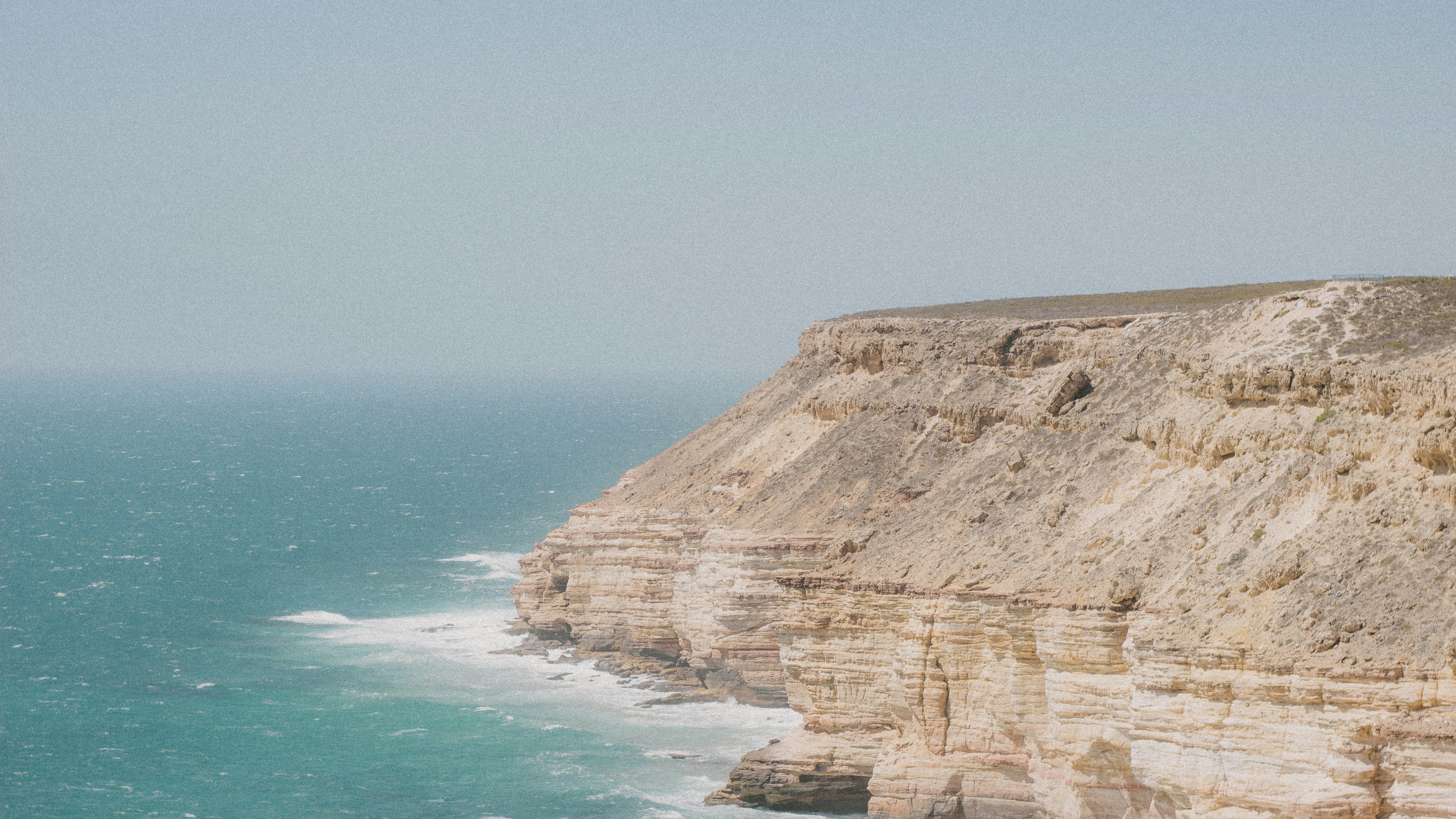 Brown rock formation near body of water during daytime photo – Free ...