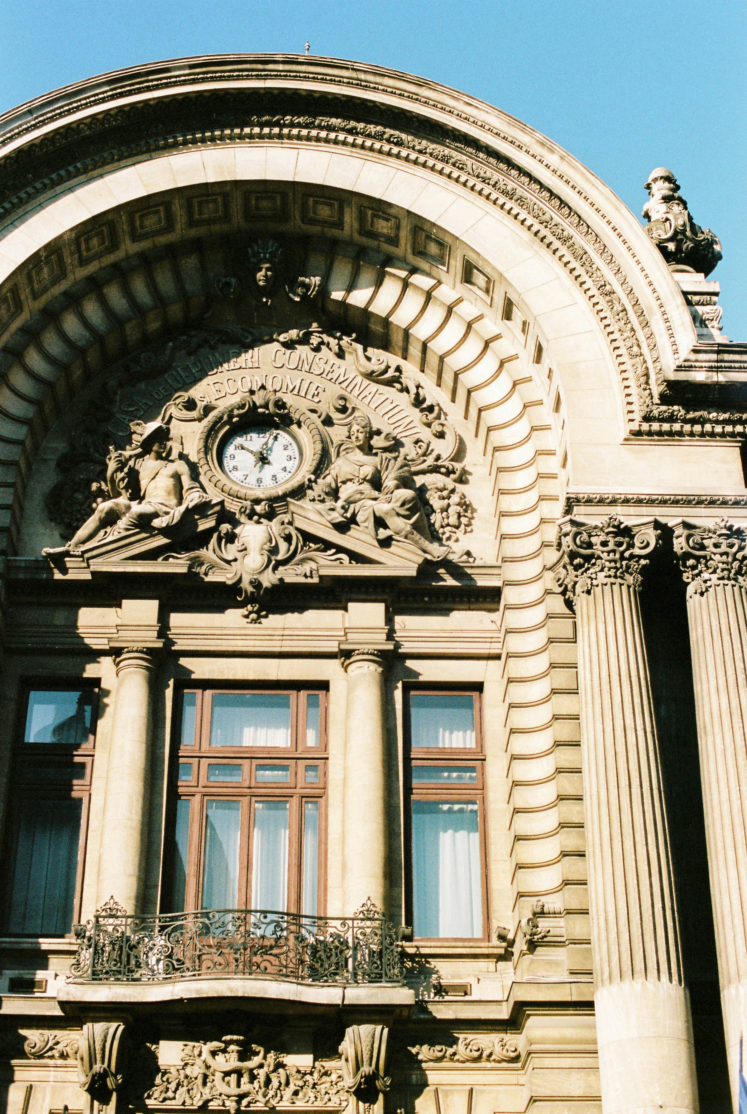 Heraldic Archway: Clock, Columns, and Carved Reliefs