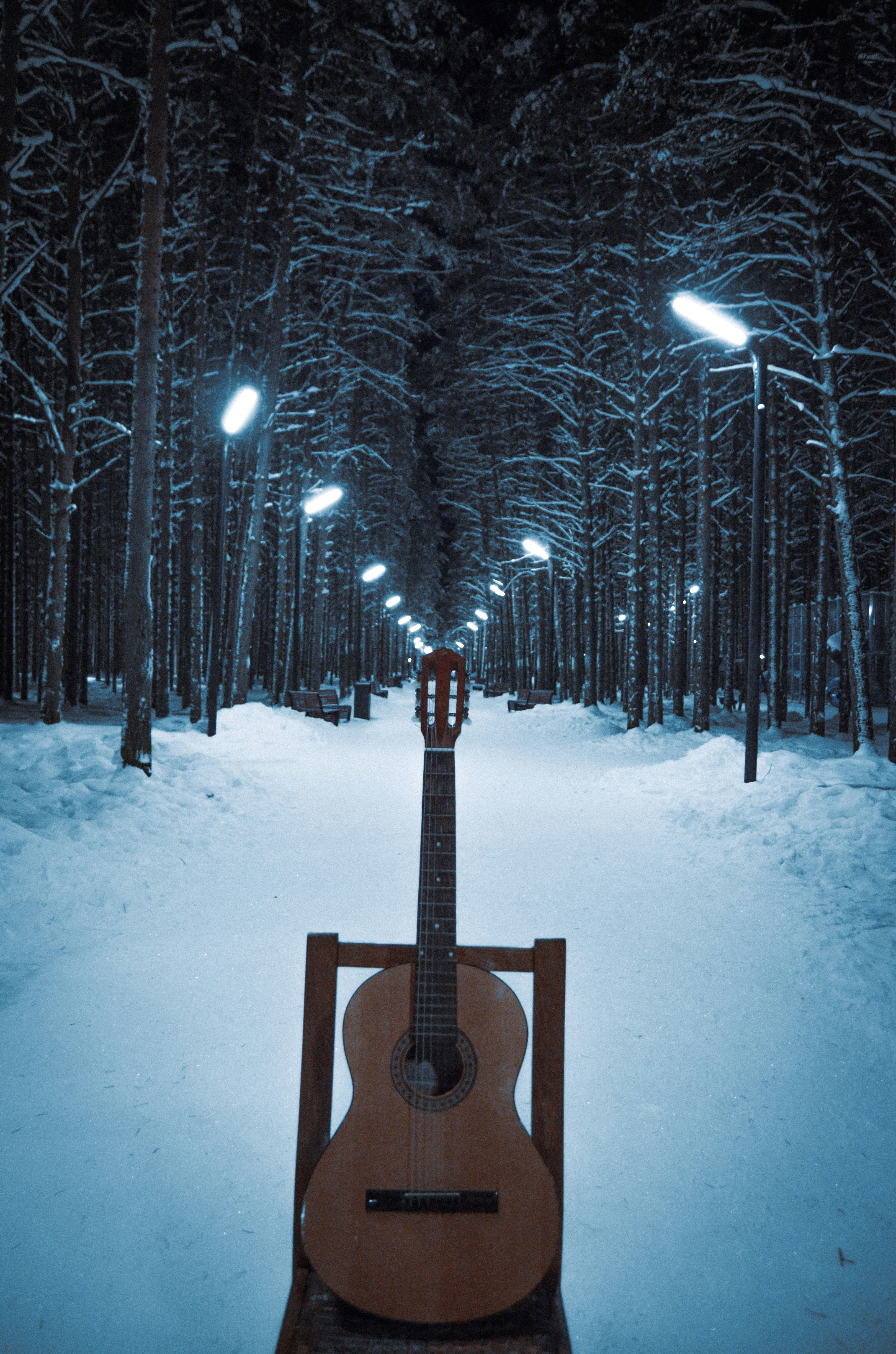 Acoustic Pathway: Guitar Beneath a Winter Street of Lights