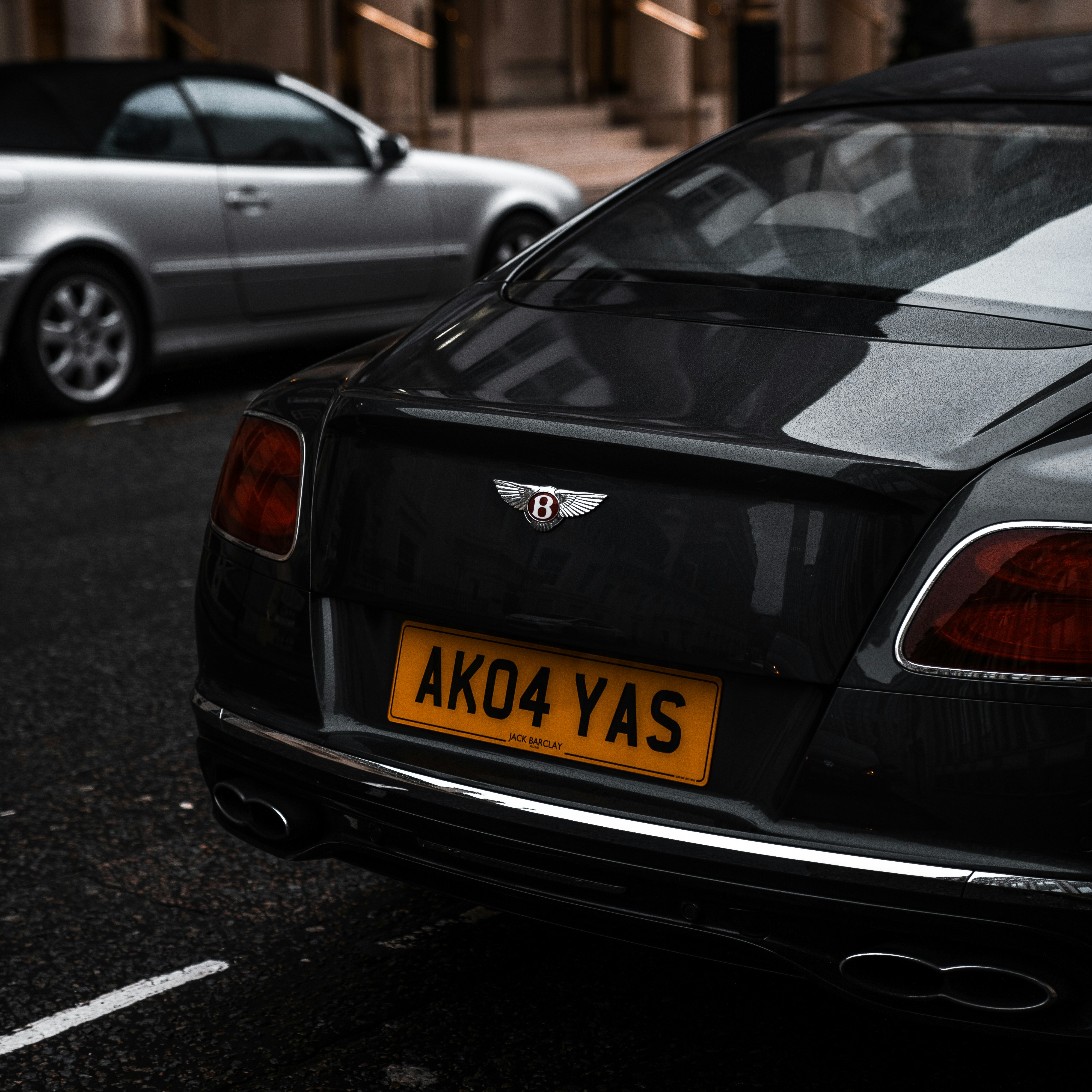 Rear Badge Reflections: A Black Bentley in a Quiet Street