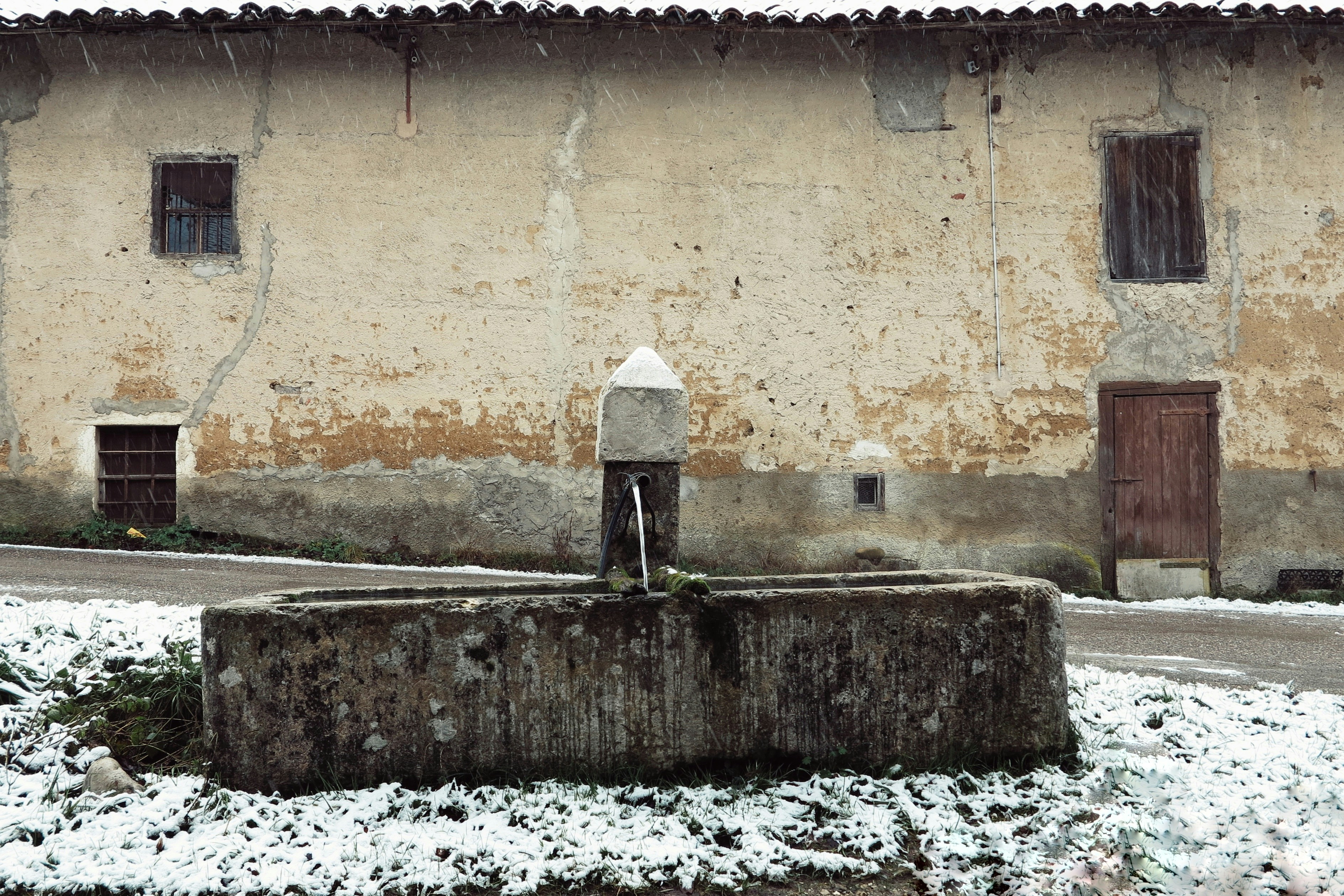 Winter's Quiet Fountain: Snow-Dusted Courtyard