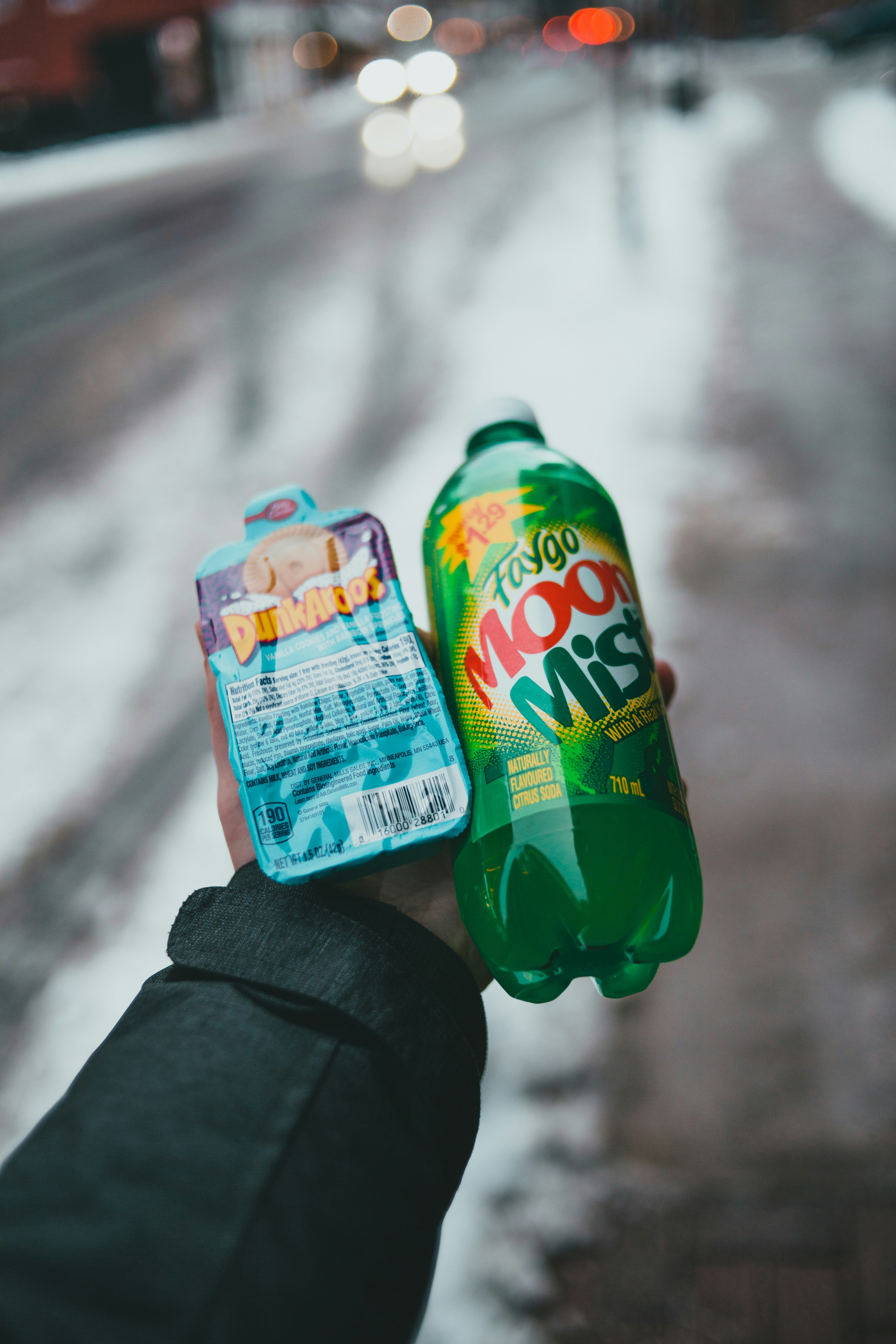 Blue and Green Bottles in Hand: A Snowy City Street Portrait