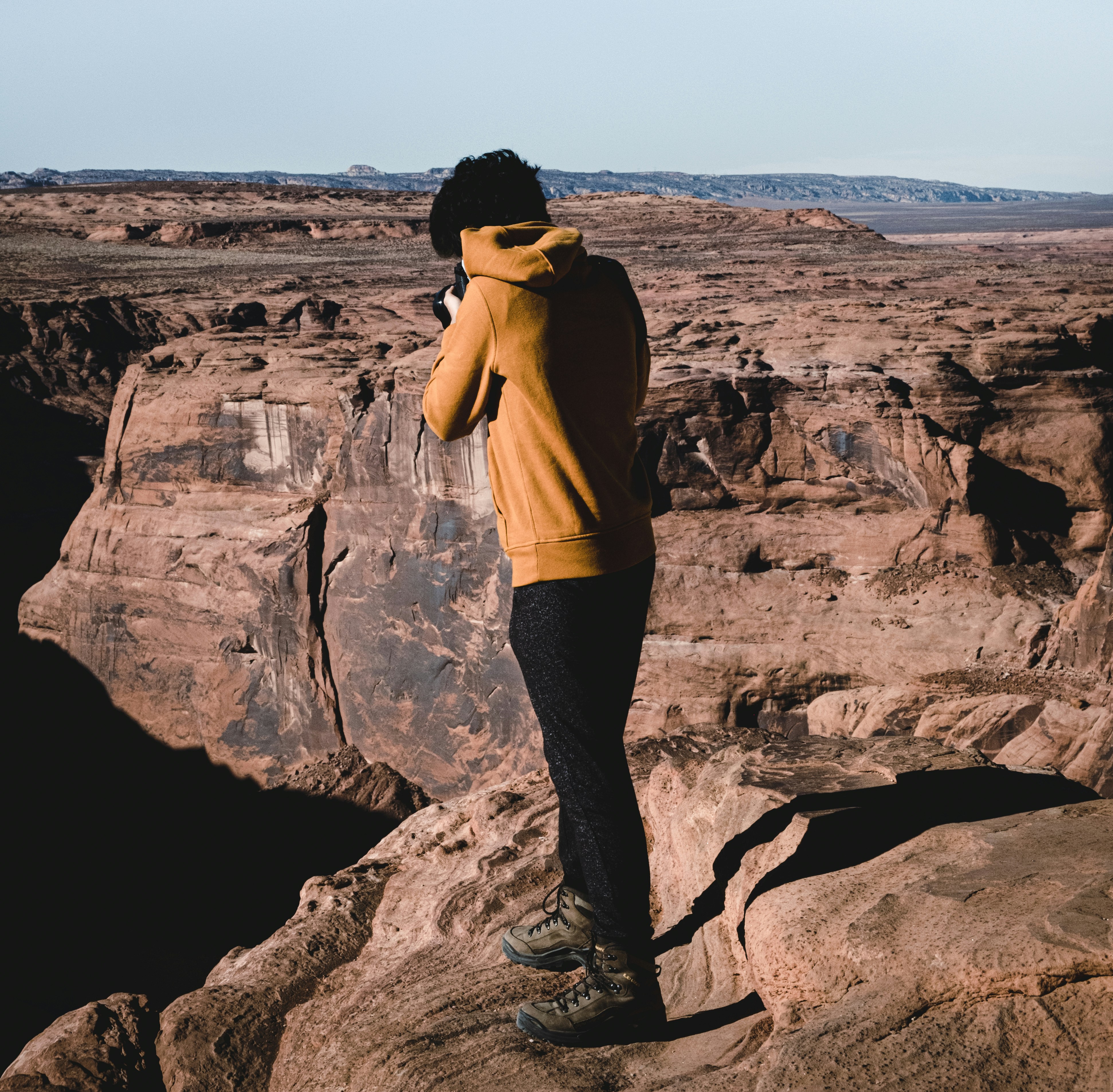 Standing on the Edge: A Lone Figure Over the Canyon Rim