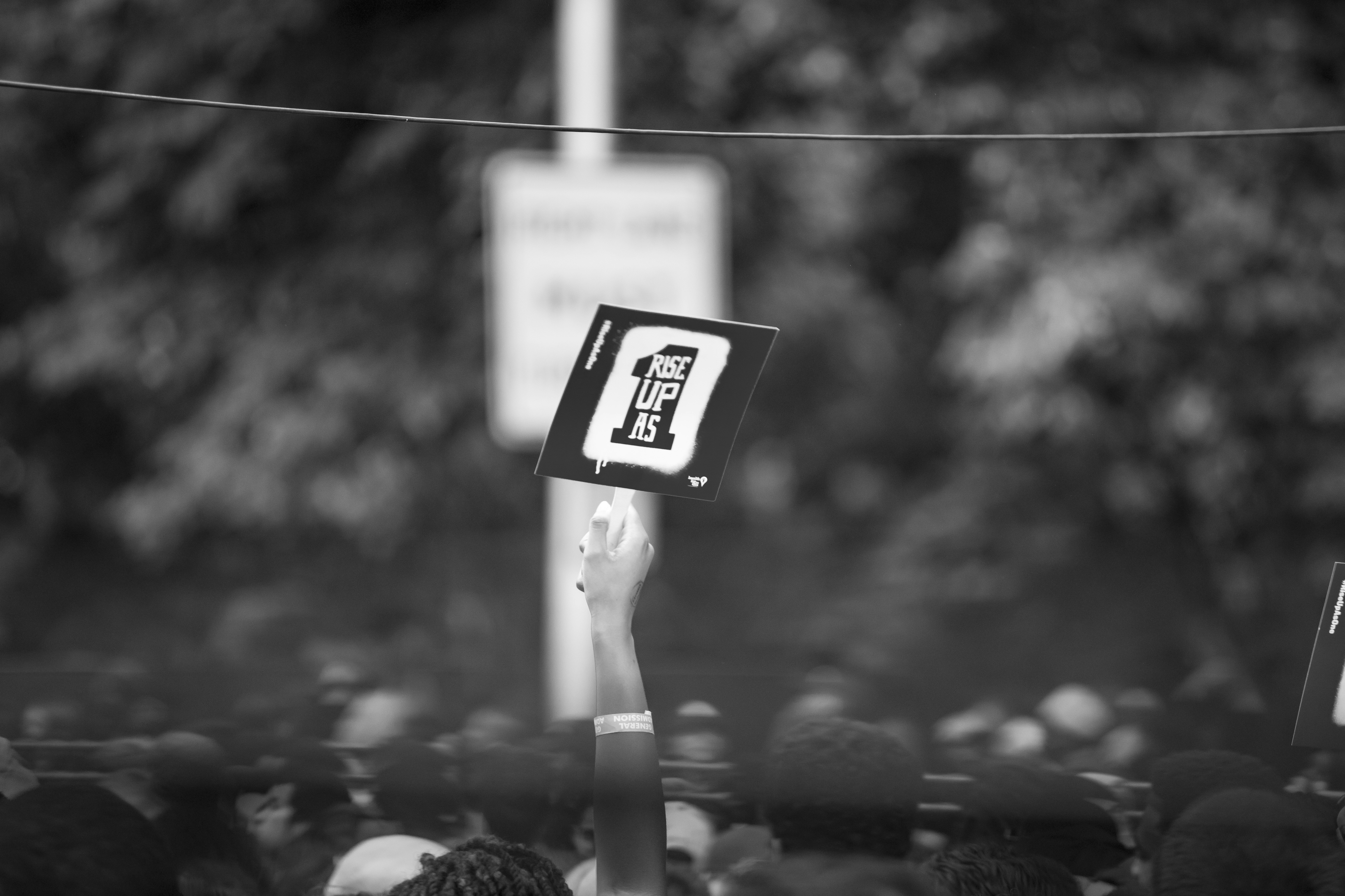 Grayscale photo of person holding stop sign photo – Free Grey Image on ...
