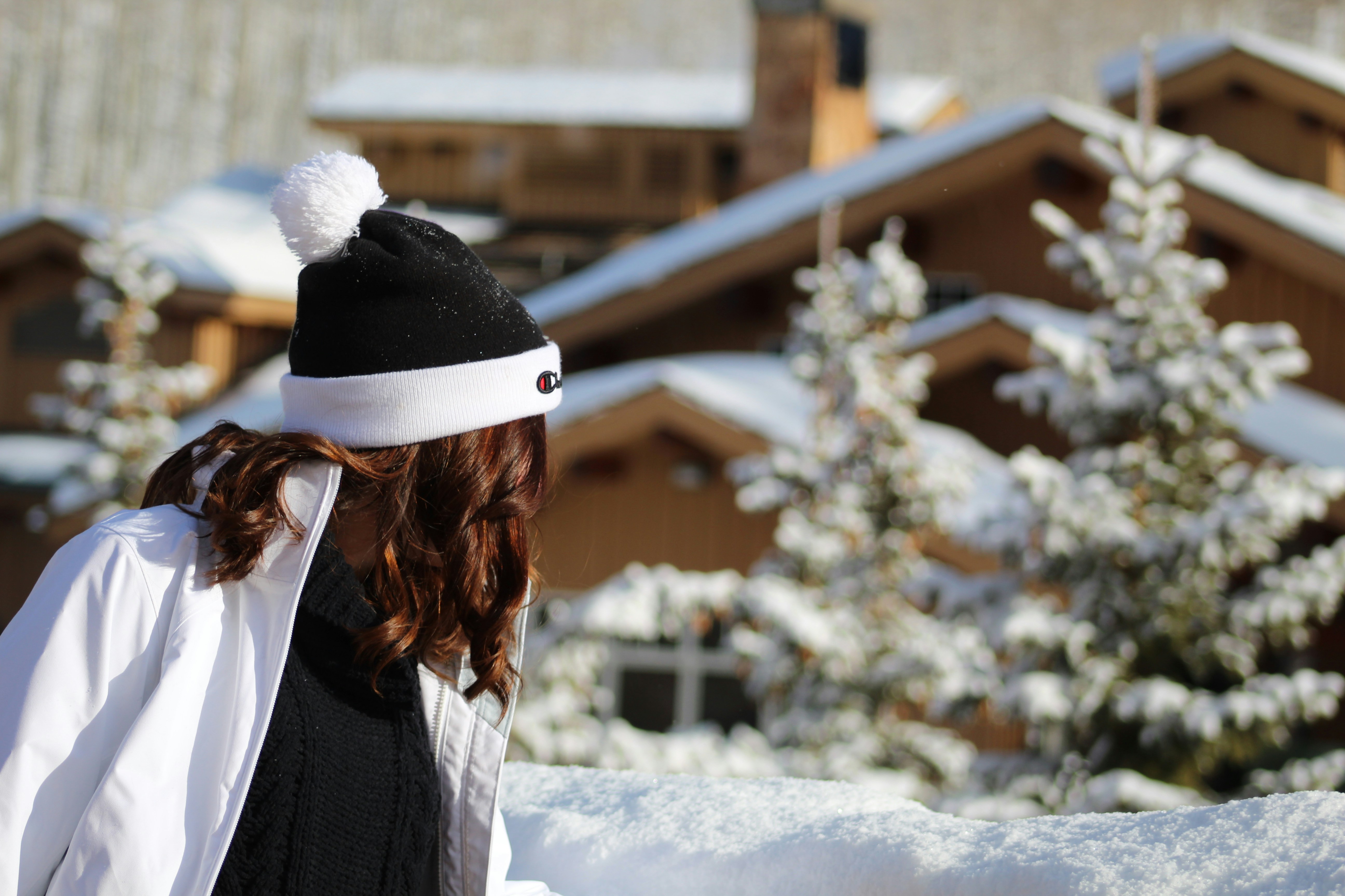 Winter Gaze: A Cozy Portrait Amid Snowy Chalet Backdrop