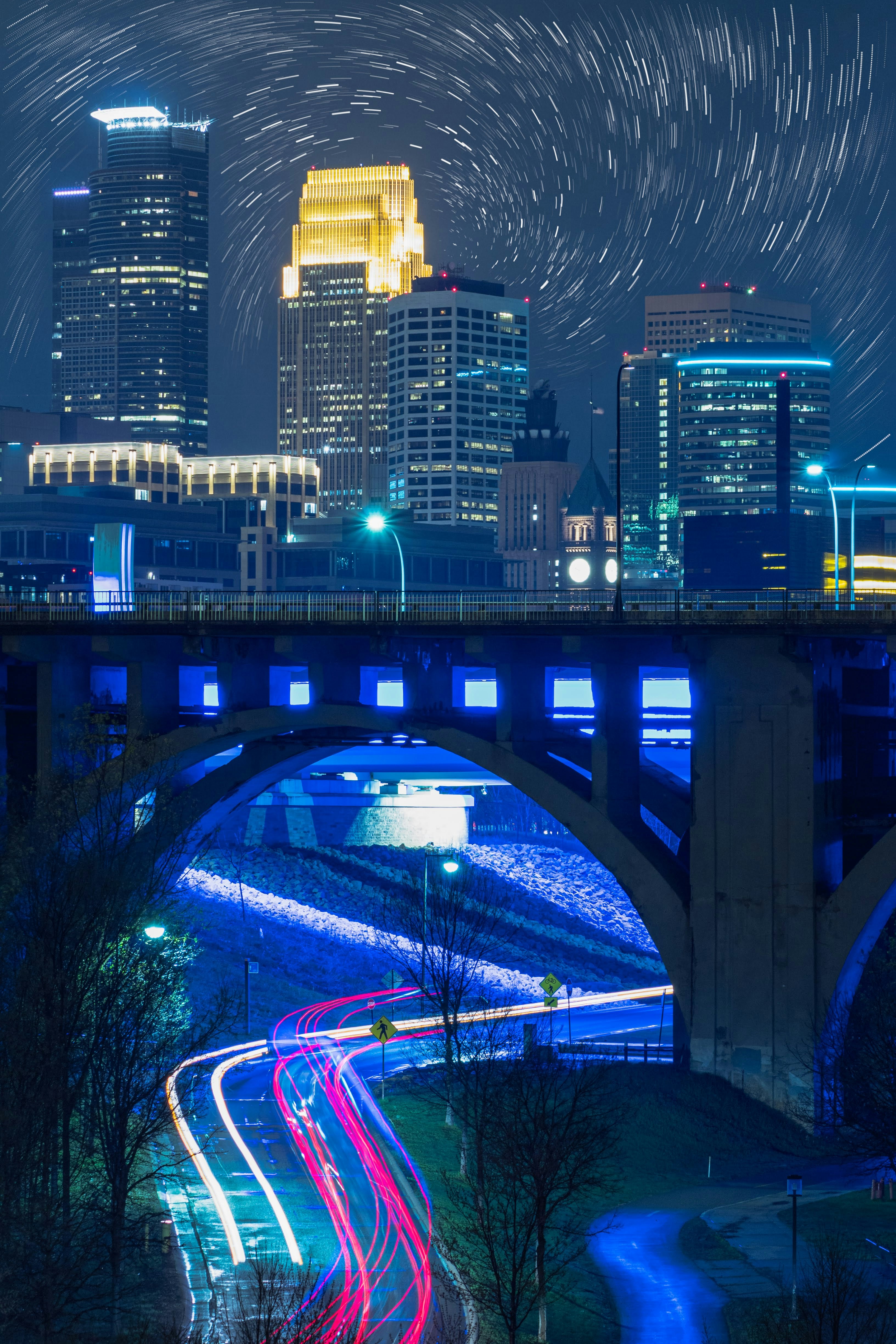 Circular Nightfall: Star-Trails Over a Neon River City