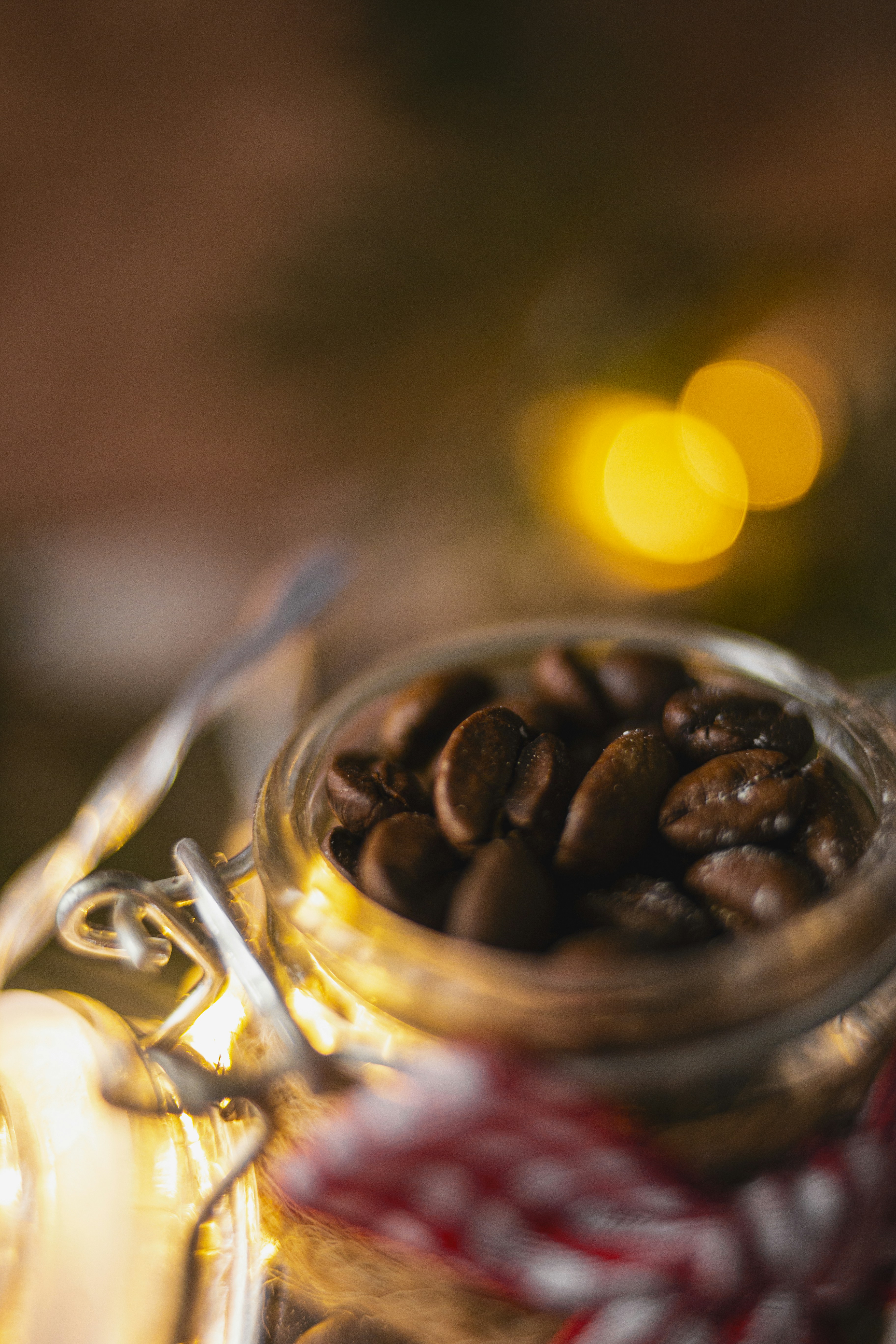 Warm Glow: Coffee Beans in a Jar Amid Soft Evening Lights