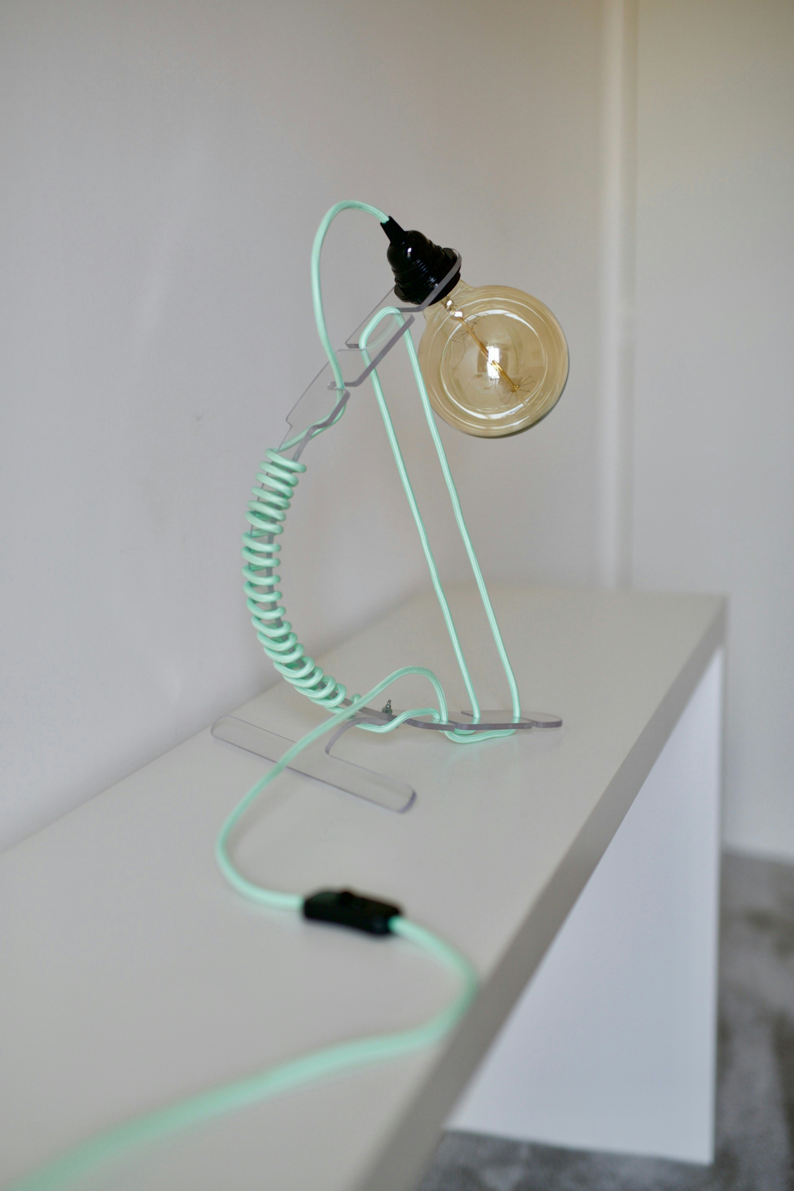 green and black earphones on white wooden table