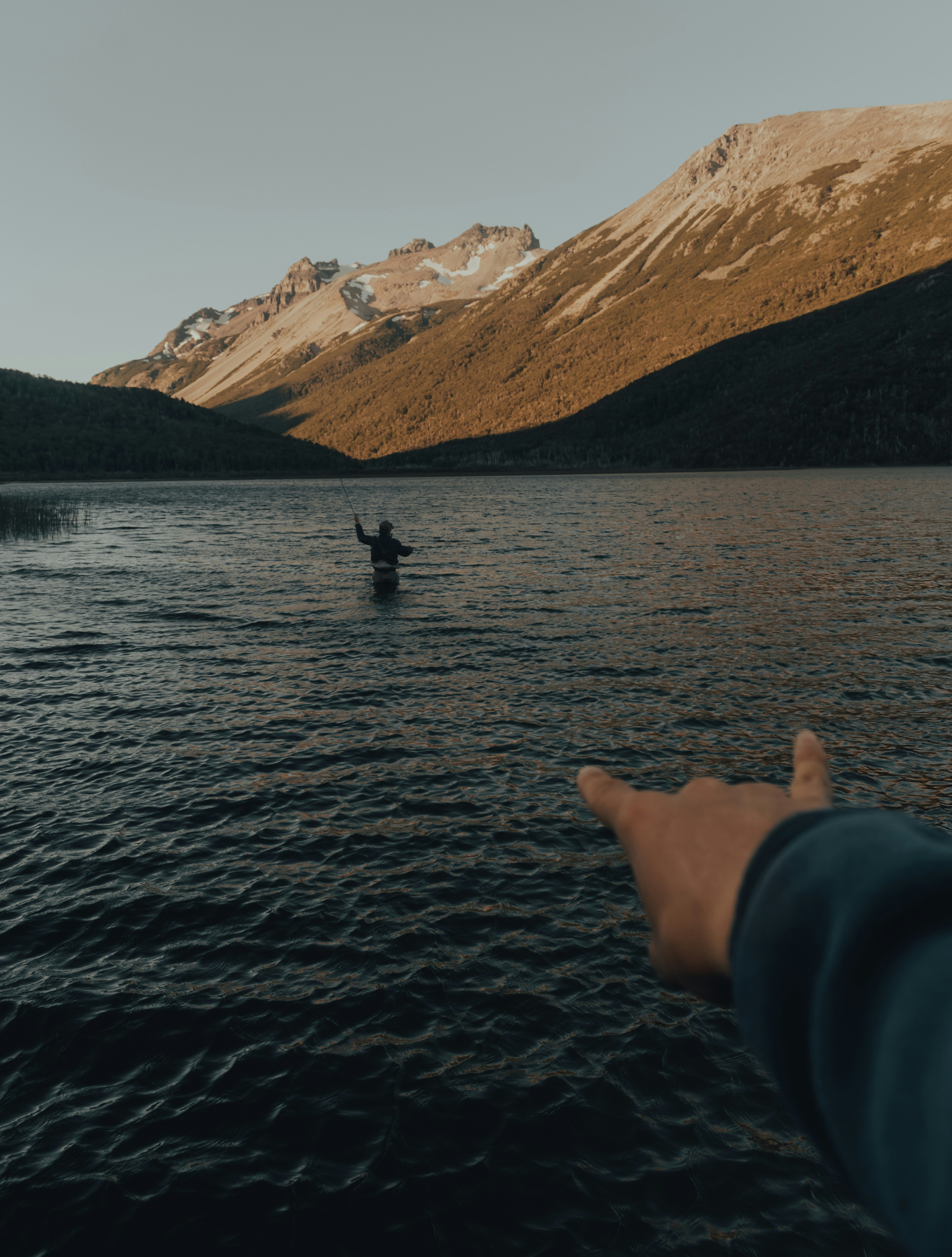 Outstretched Reach Across a Mountain Lake