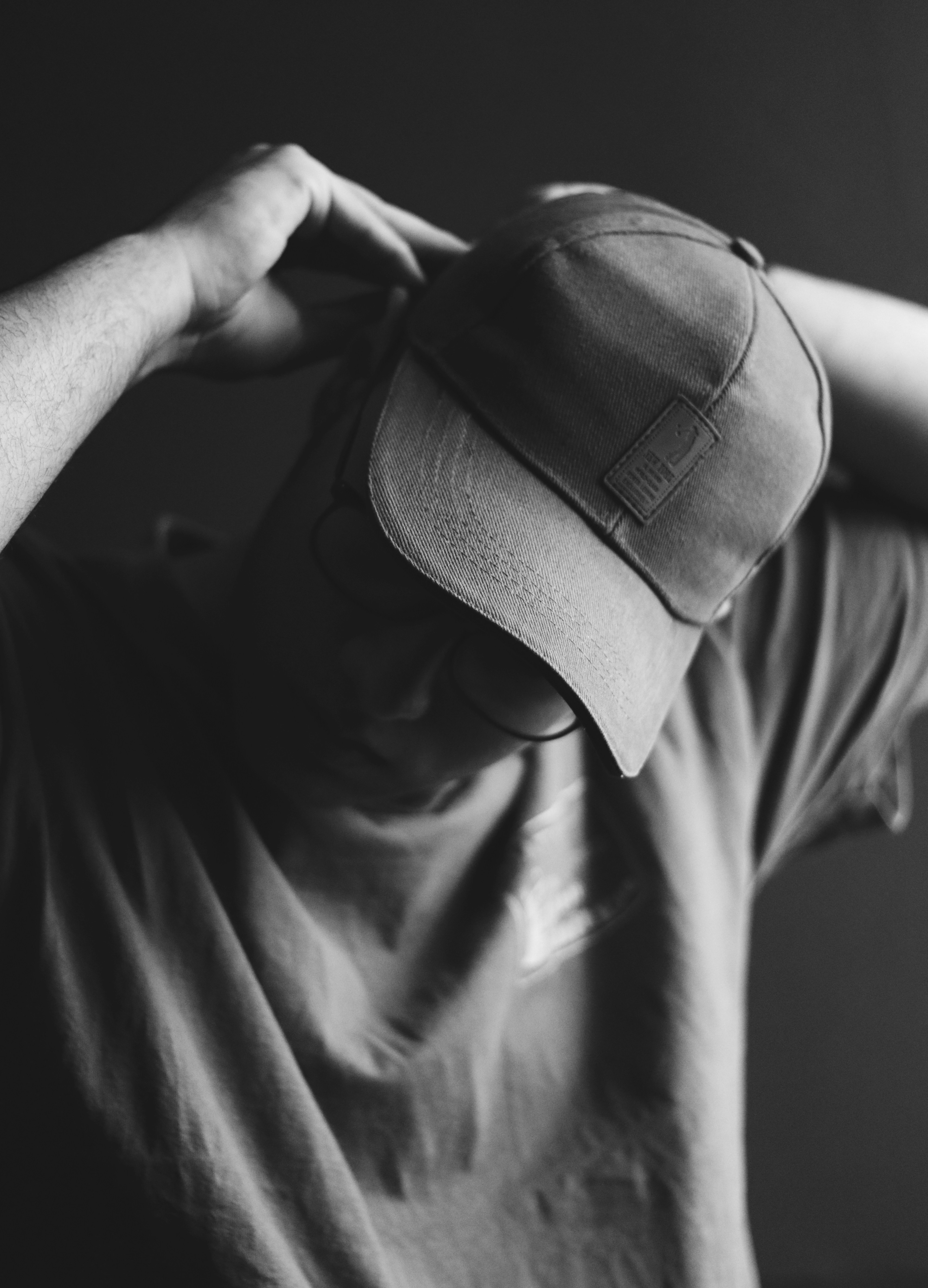 Grayscale photo of person holding cap photo – Free Grey Image on Unsplash