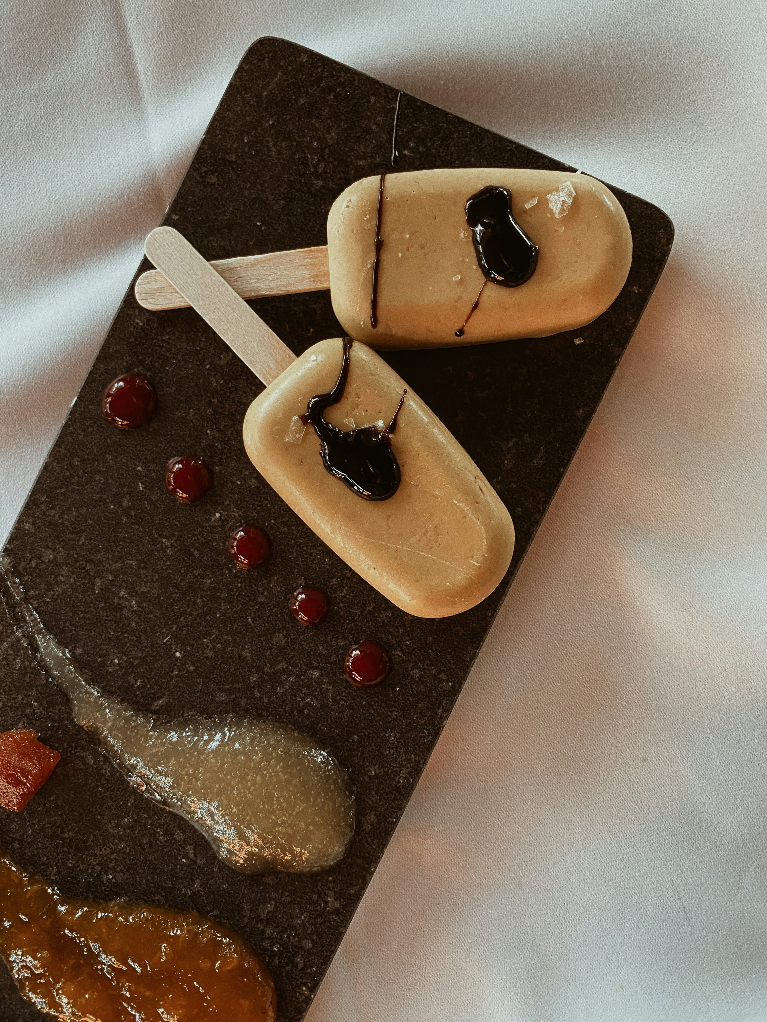 Vanilla Pops on Slate: Pale Treats with Midnight Drizzle