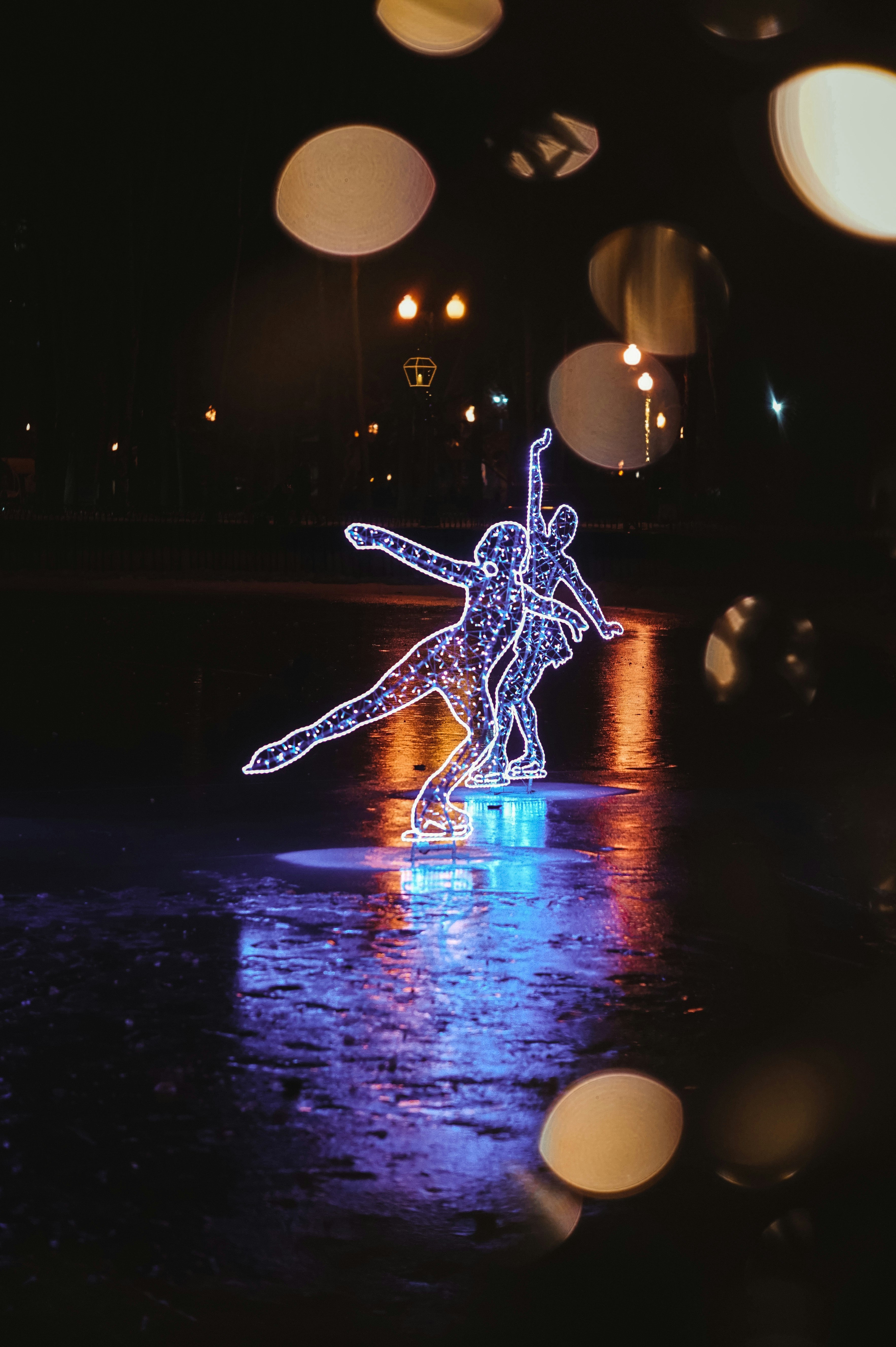 Neon Ice-Dance Duo on a Night-Reflective Stage