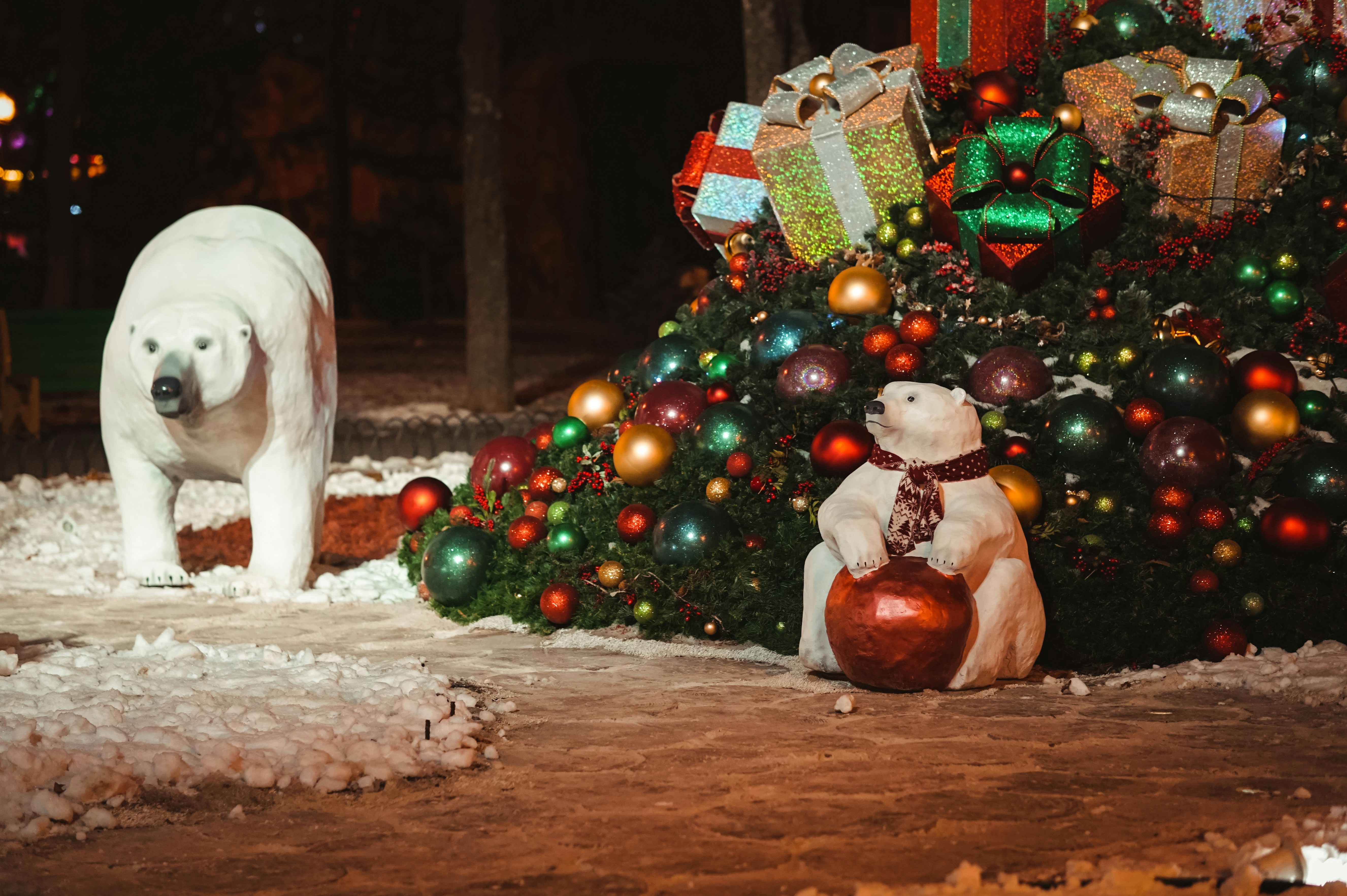 Winter Watch by Festive Lights: A White Dog Beside a Snowman and Ornamented Tree